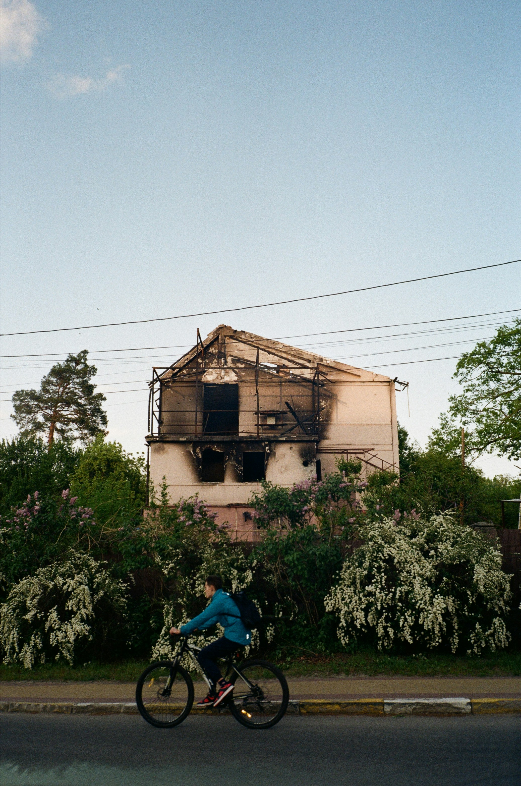 A person riding a bicycle by a building with a tower photo – Free ...