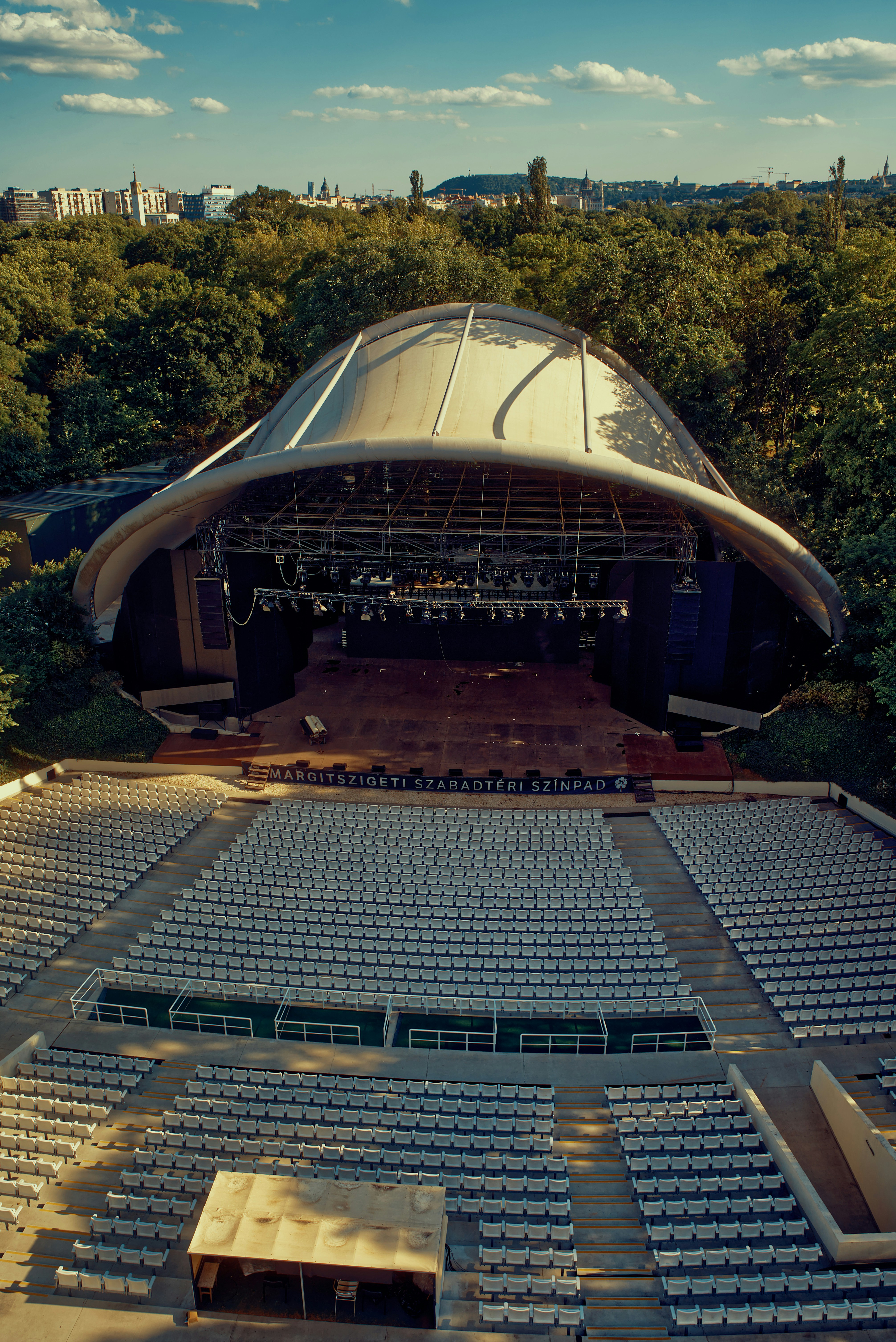 Open Air Opera House: Aerial View of a Full Seats Arena with Forest Backdrop