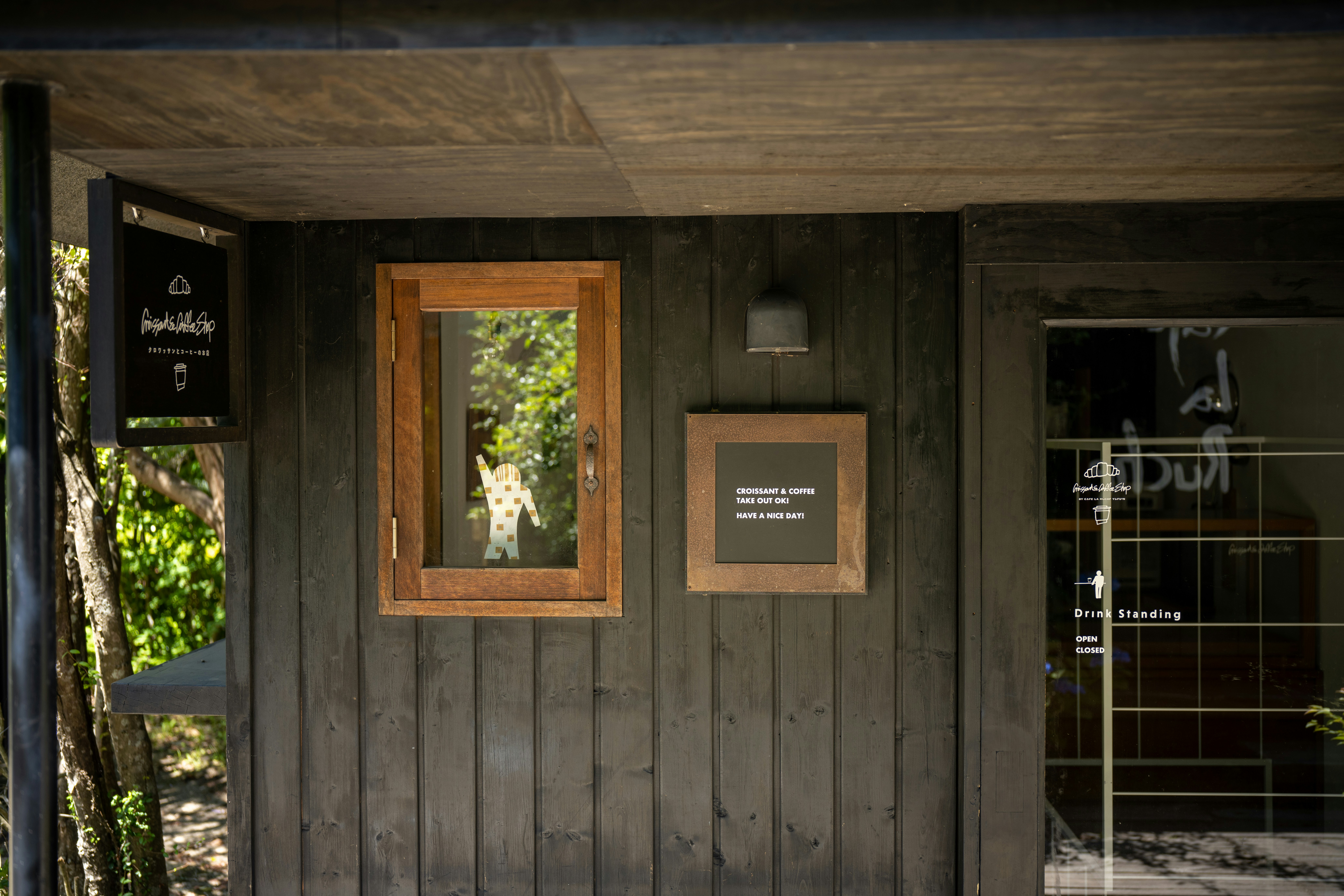 Amber-Framed Window Anchoring a Quiet Wooden Storefront