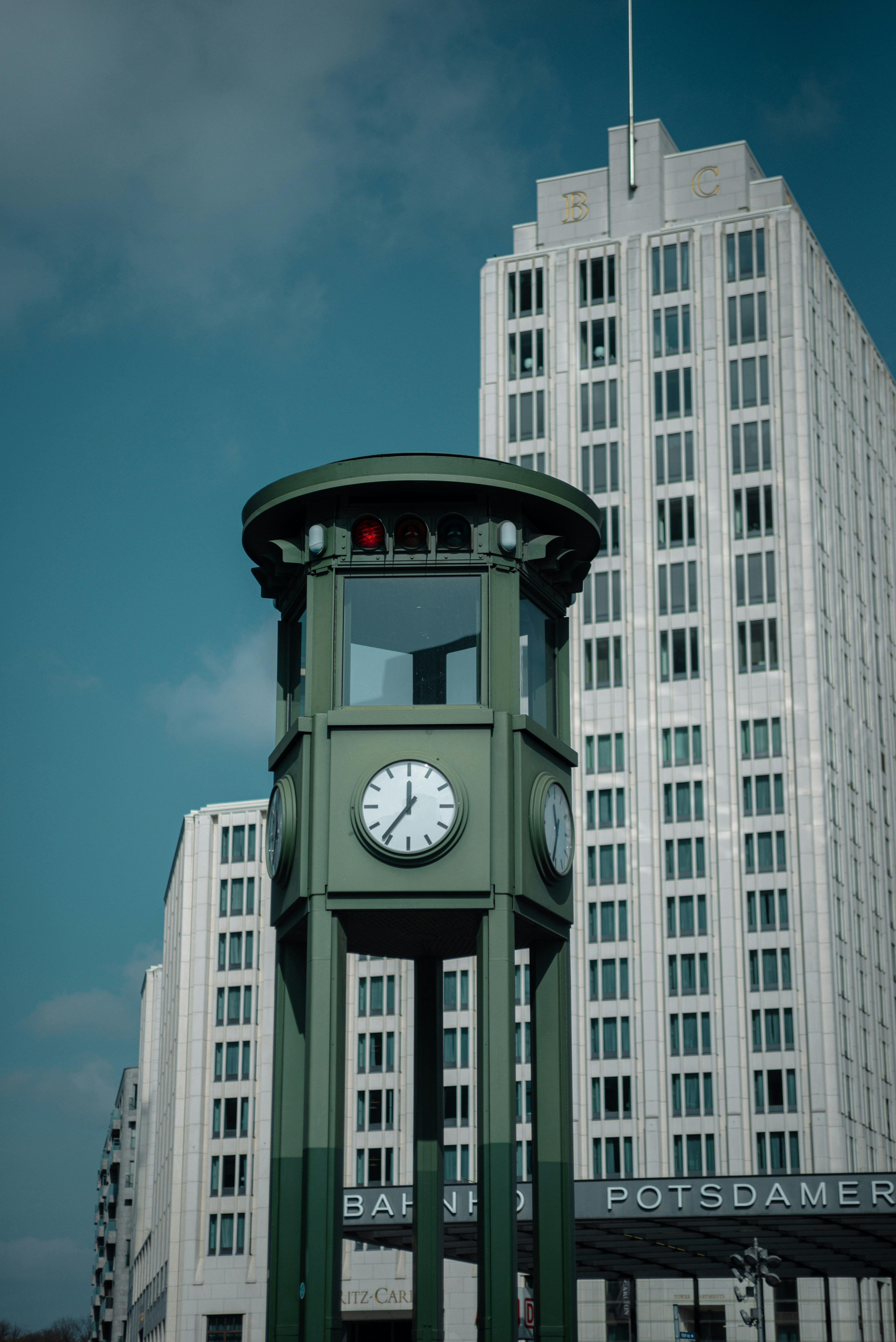 Verdant Clock Tower Framing Potsdamer's Modern Skyline