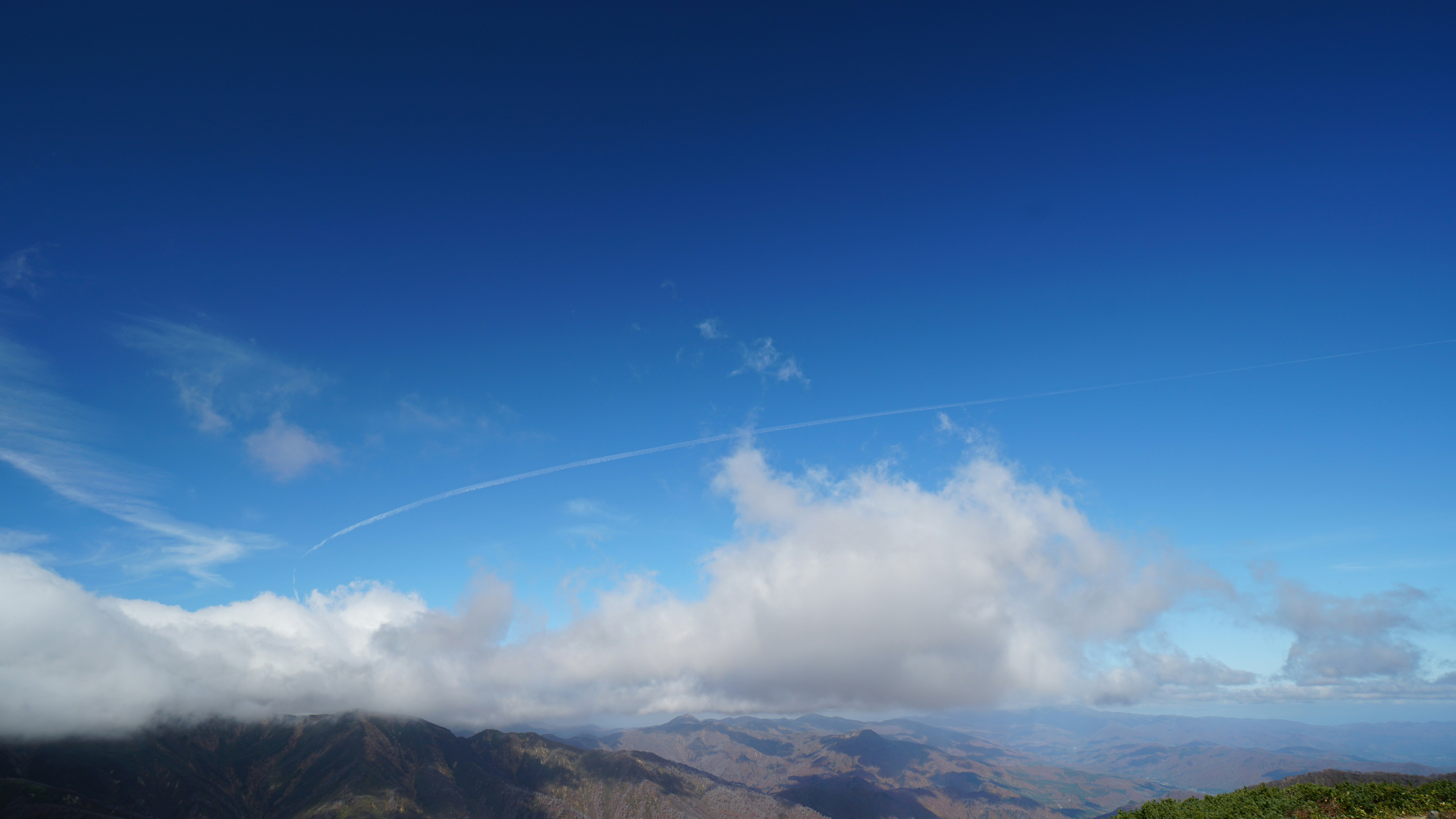 Horizon over Rolling Valleys under a Clear Azure Sky