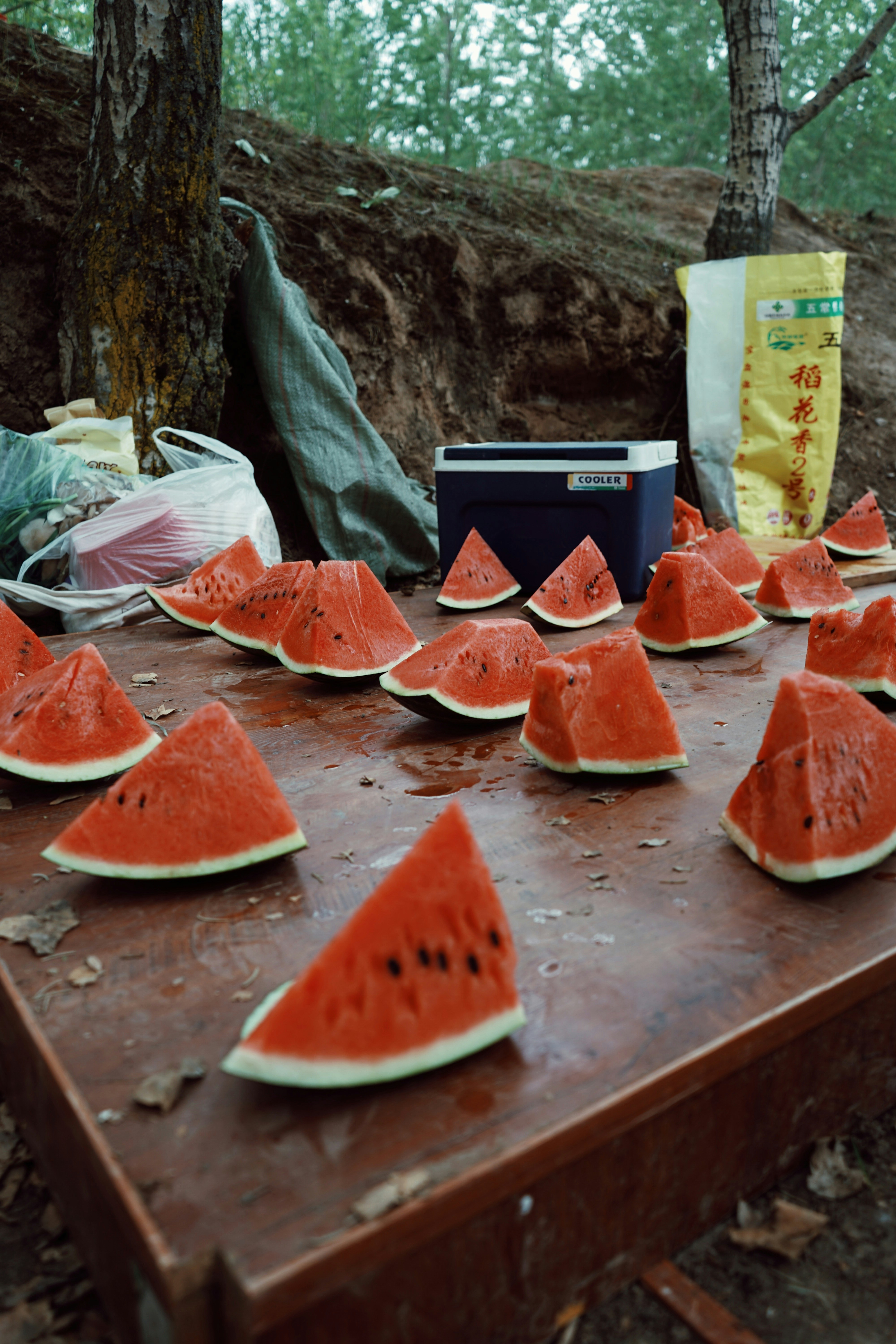 a group of slices of watermelon on a wooden table