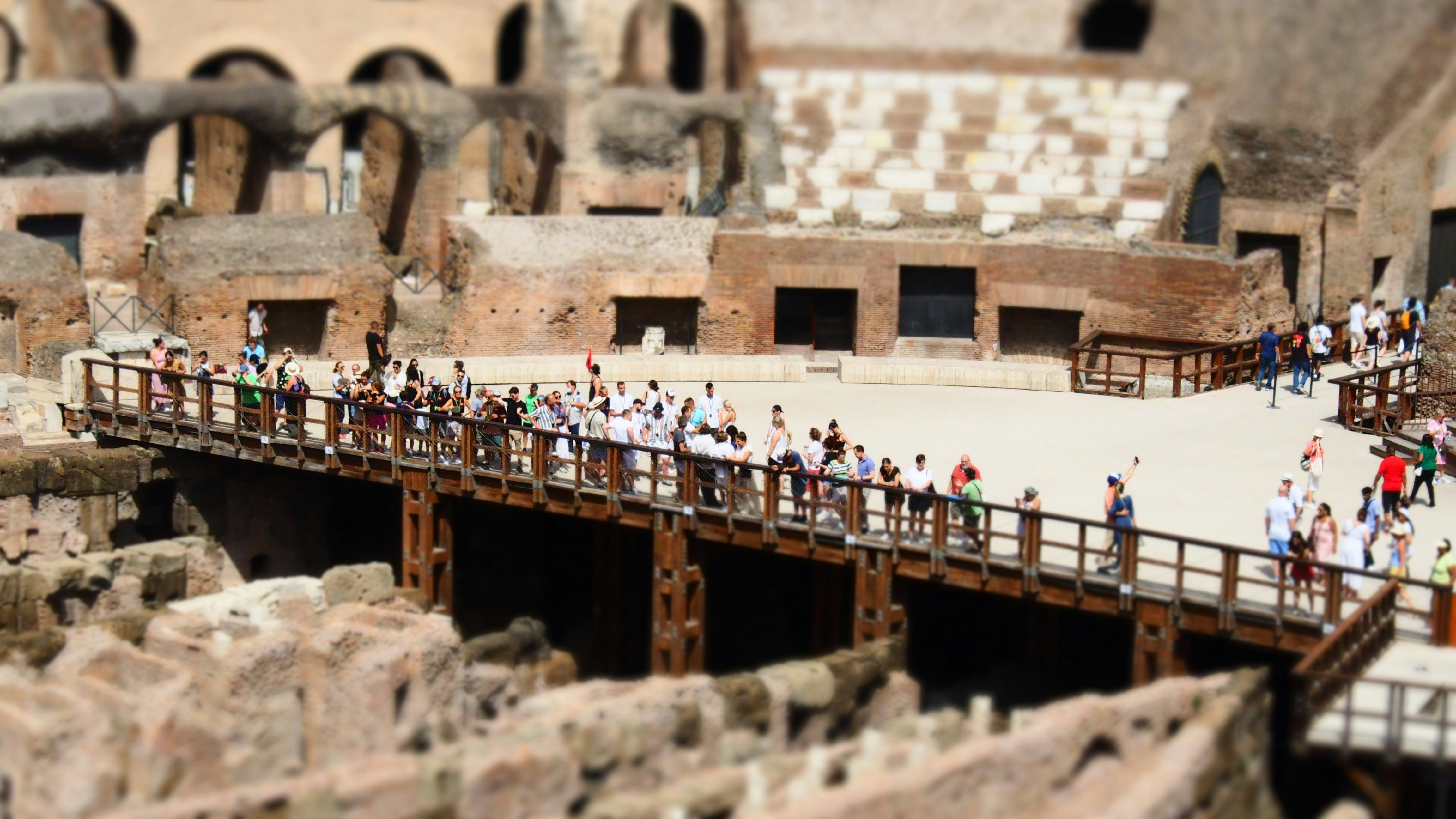 Bridge of Echoes: Crowds Cross a Timber Span Over Ancient Fortifications