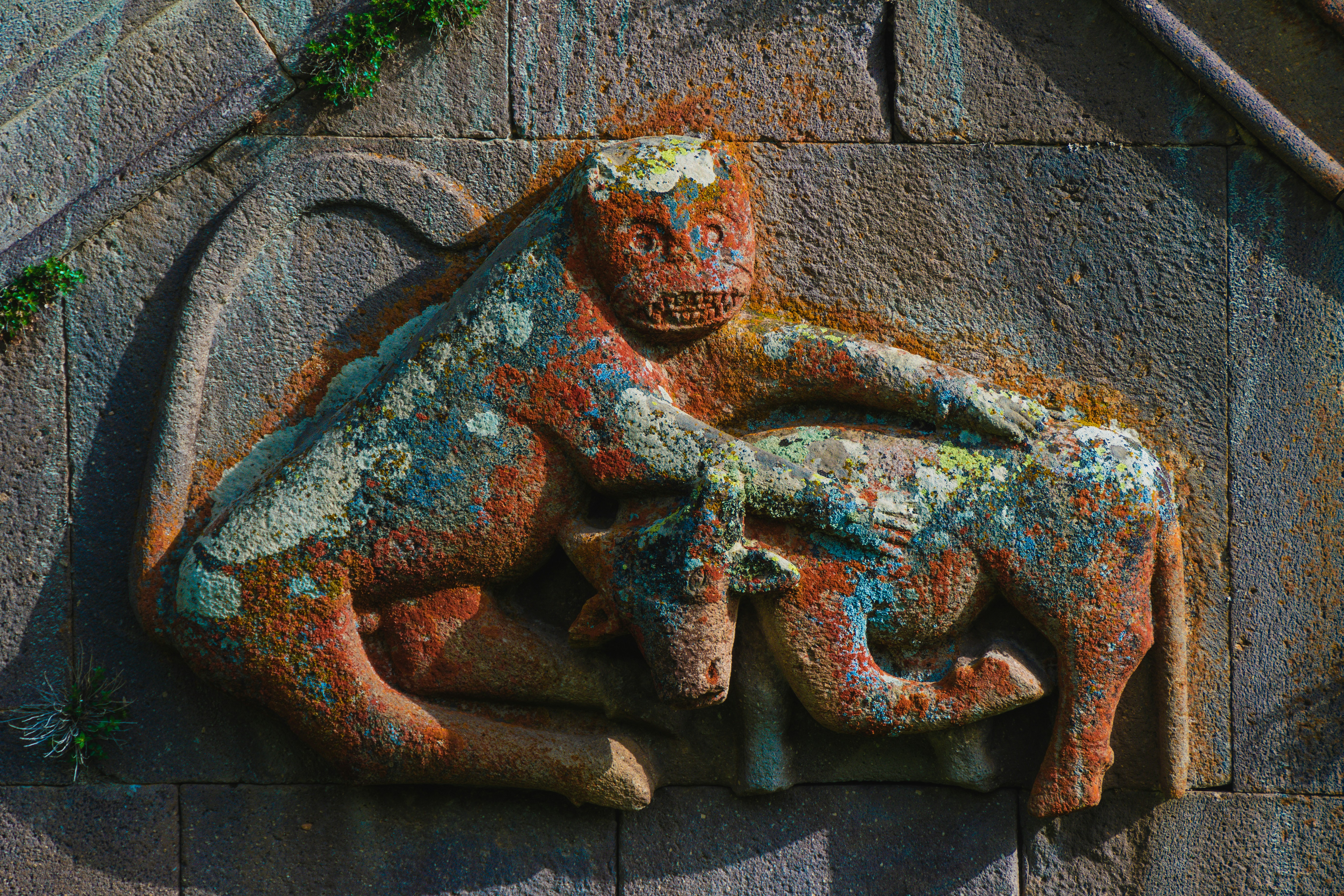a carved stone on a brick surface
