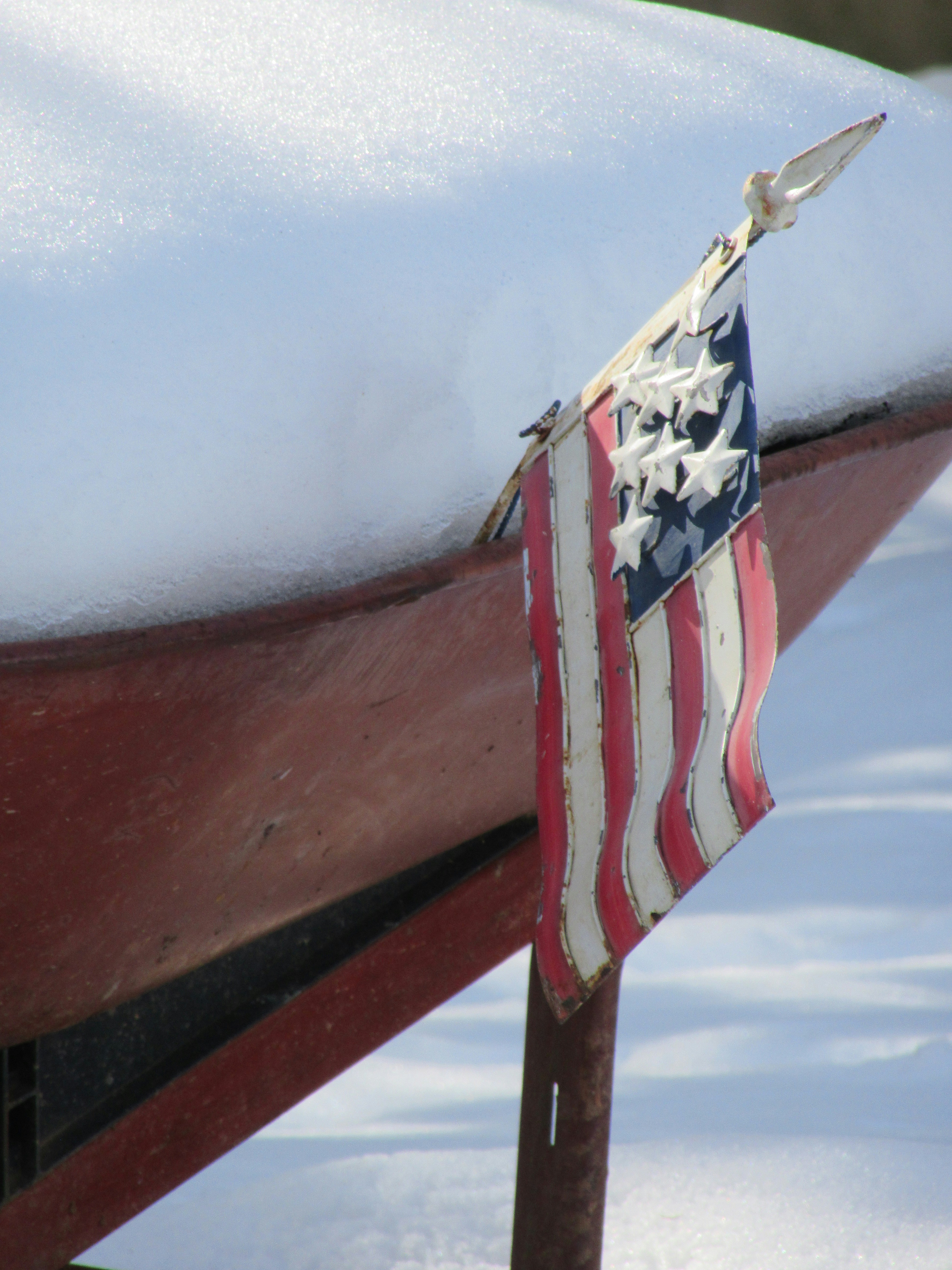 Patriotic Flag on Snow-Swept Boat Bow