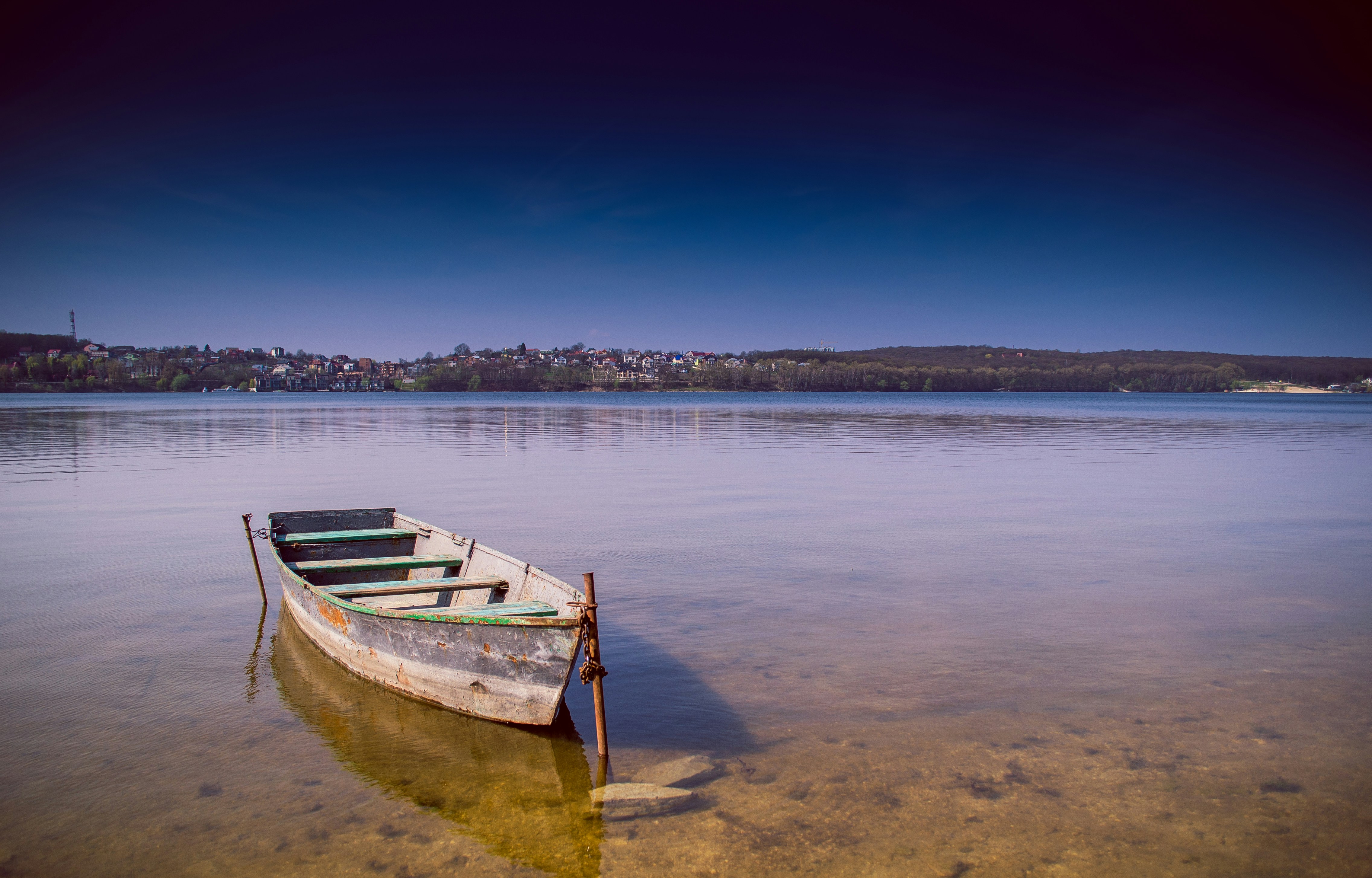 A Quiet Boat at the Edge of a Glassy Horizon