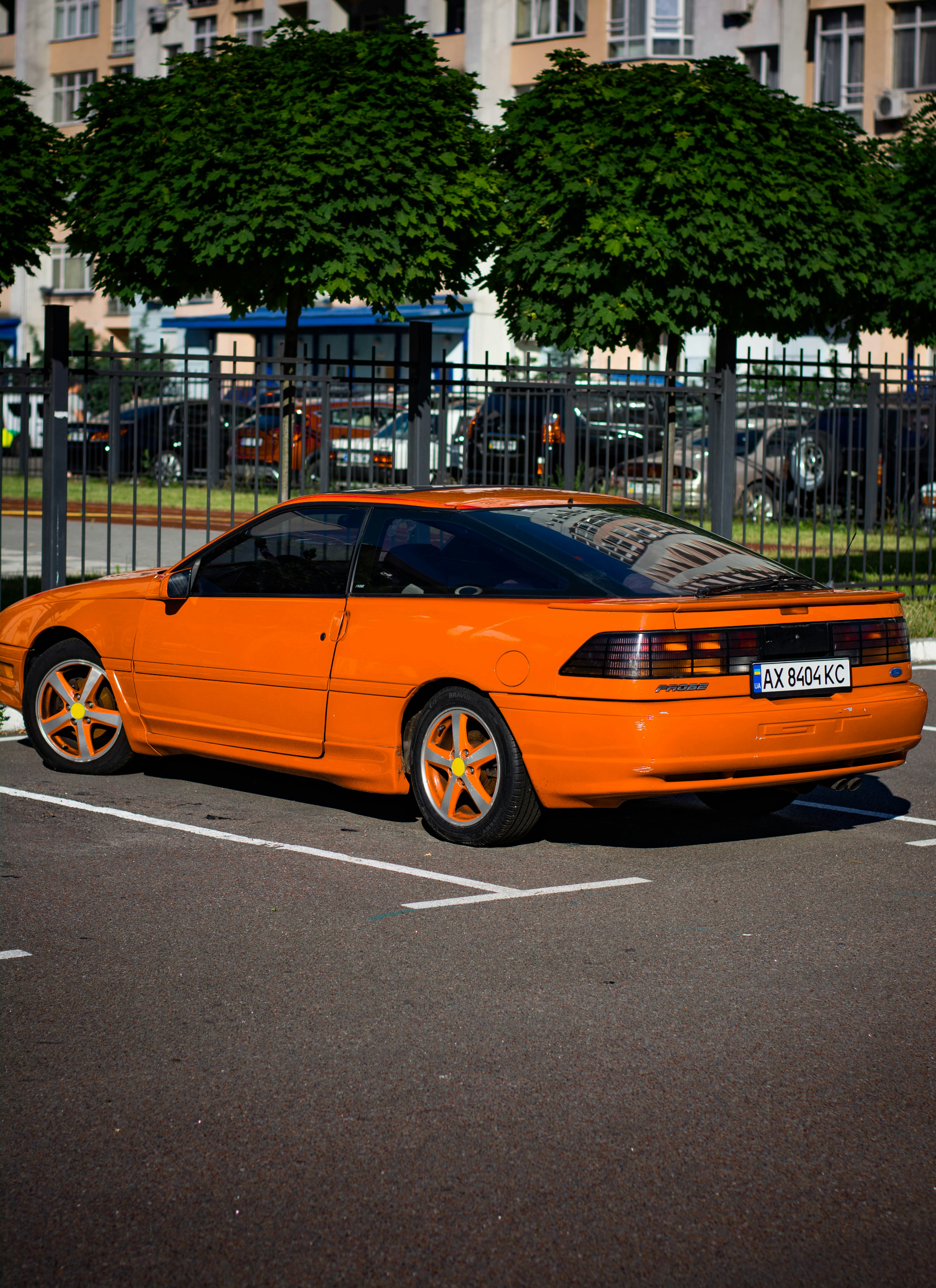 an orange car on a road