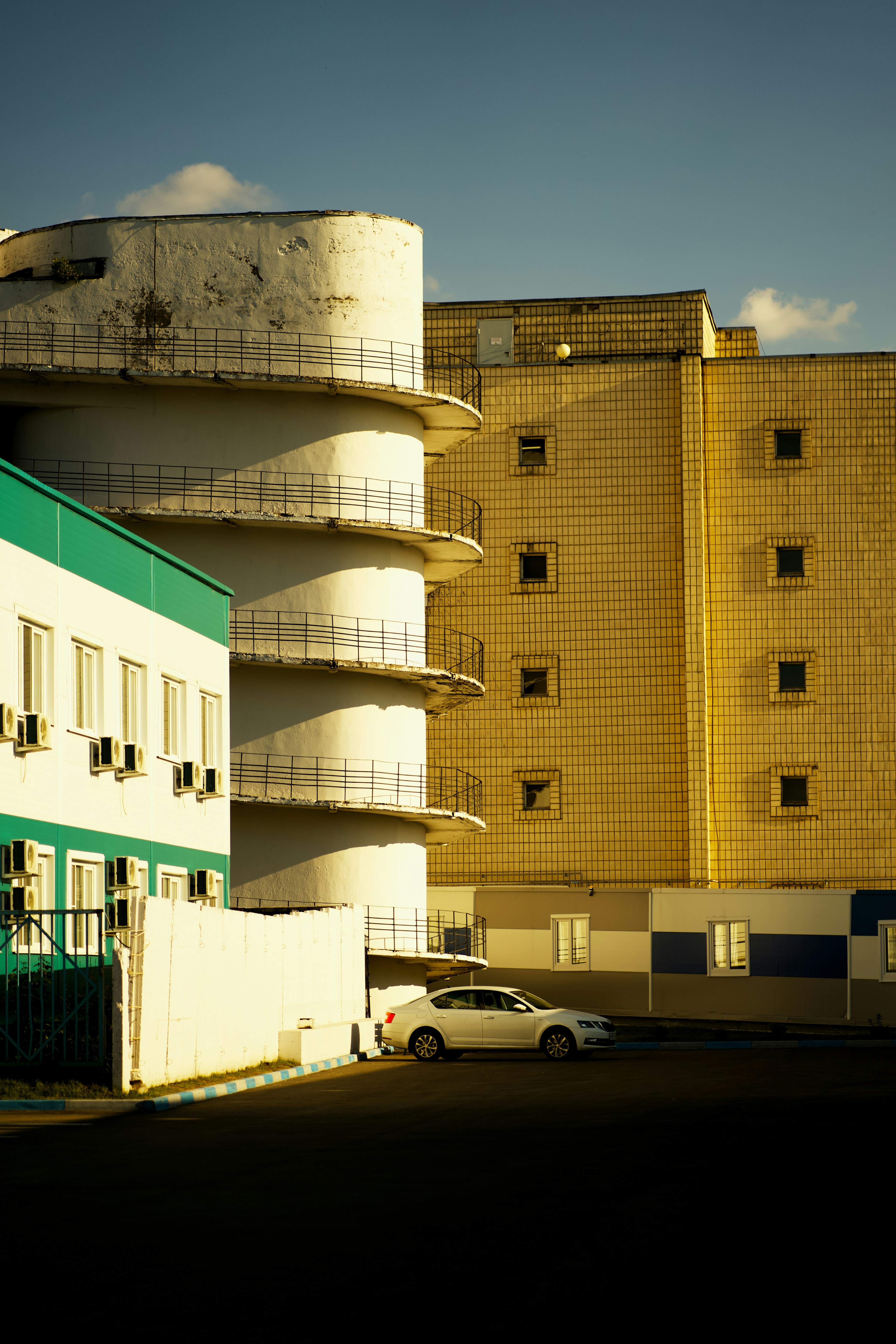 Sunlit Spiral Stairwells Against a Golden Brick Facade