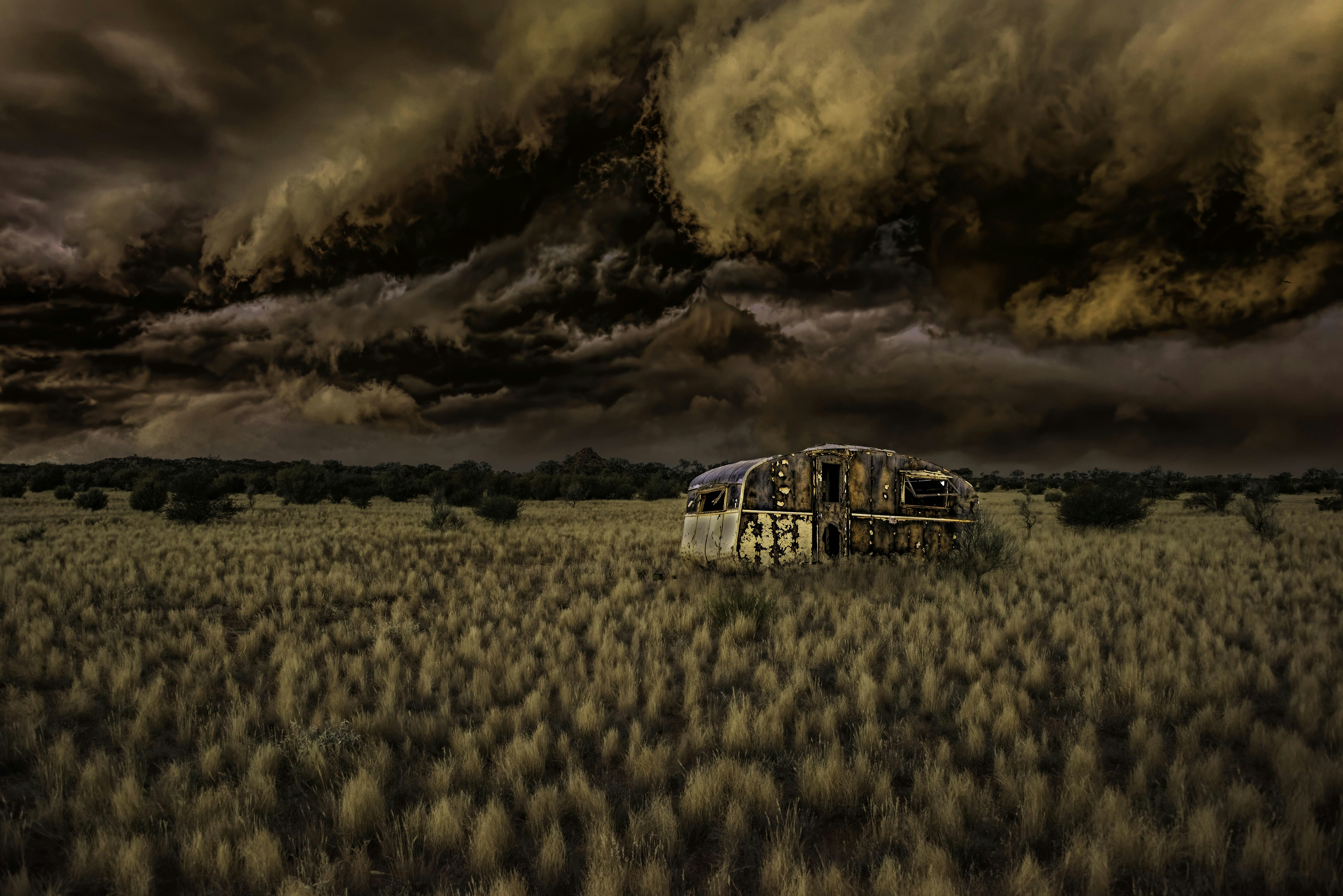 Haunted Grasslands: A Drowned Bus in a Fire-Cloud Sky