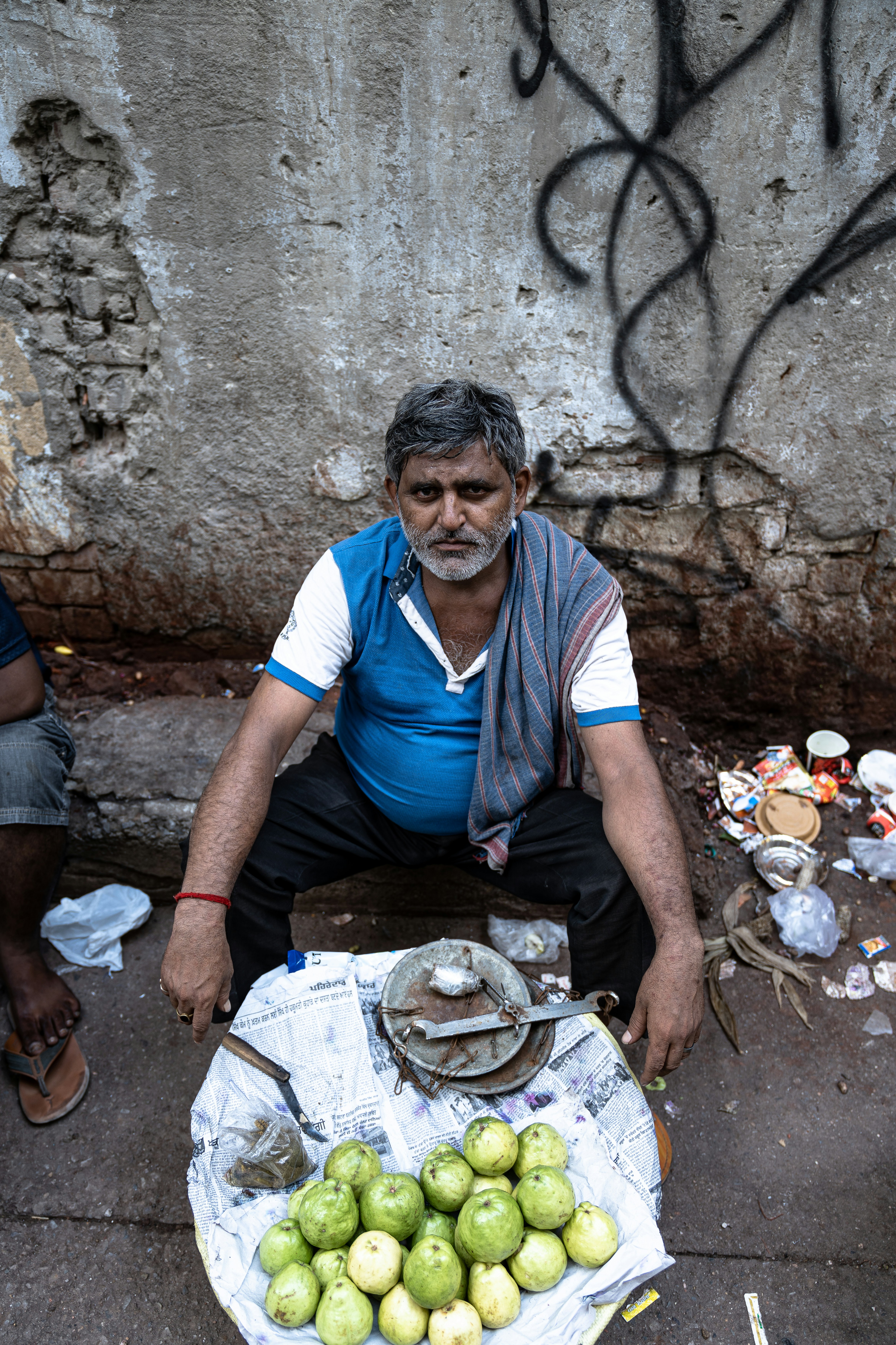 Green Guavas and a Graffiti Backdrop: A Street Vendor's Quiet Portrait
