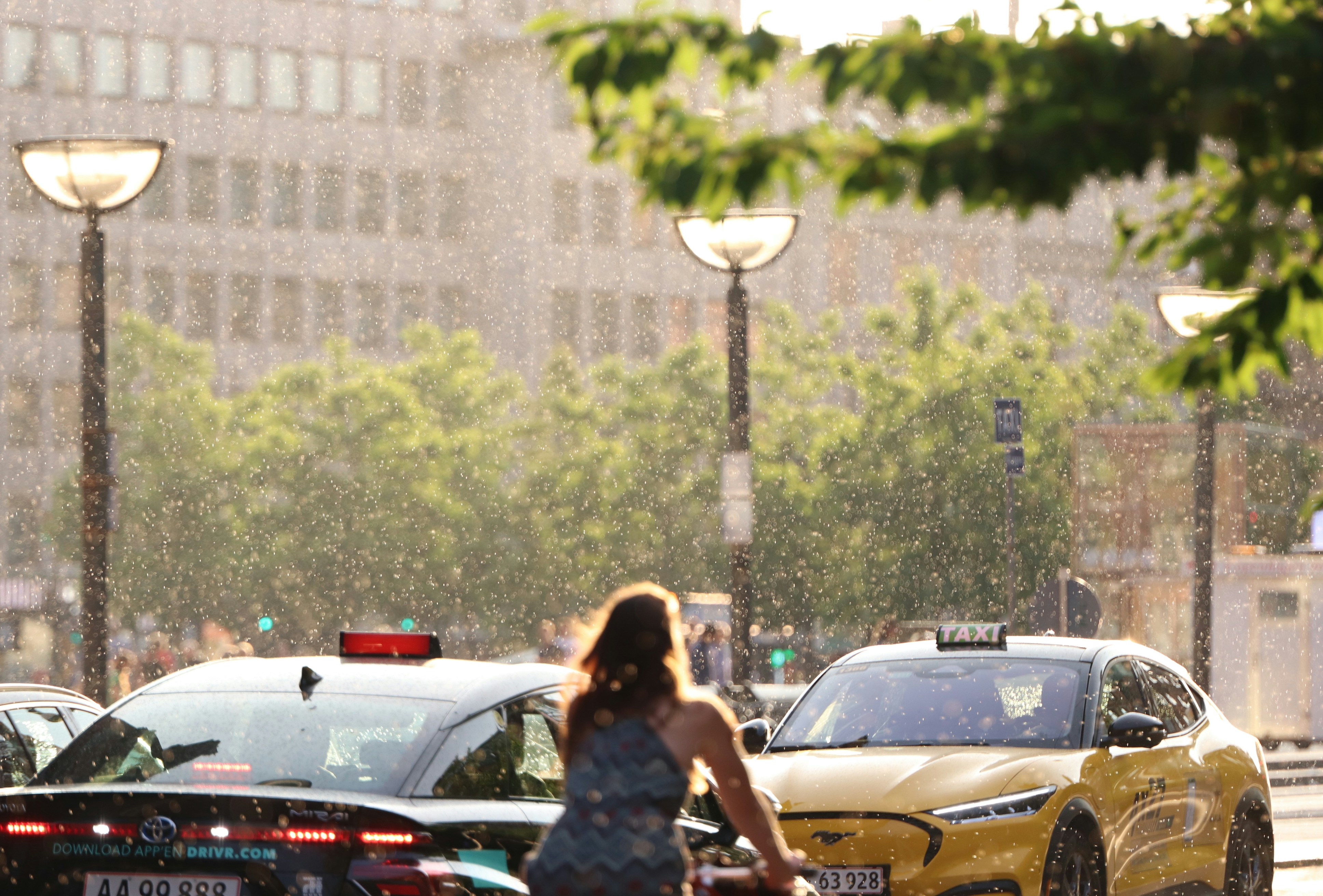 Rain-Slick Midtown: A Figure Between Police Cars and a Yellow Taxi