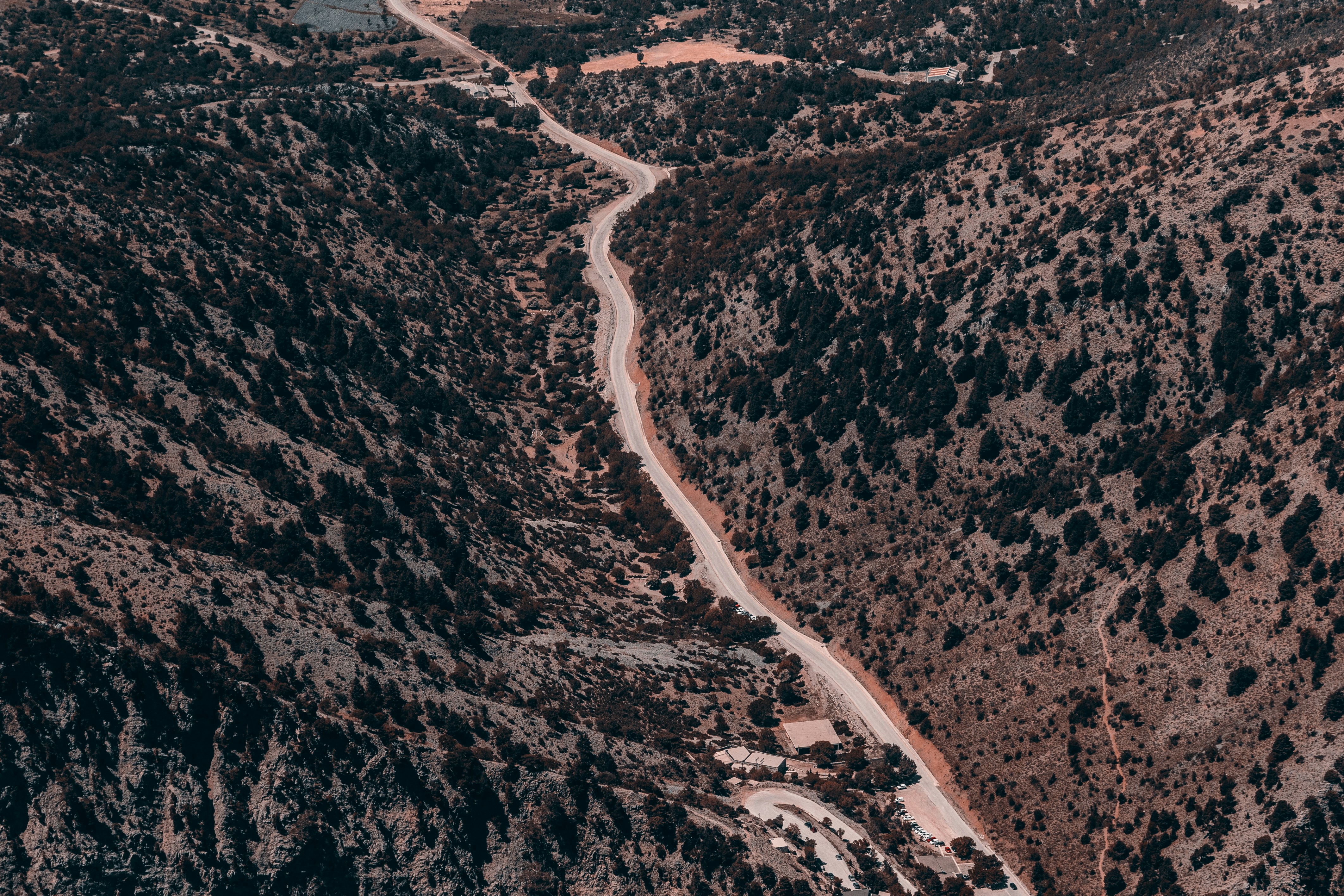 Copper Serpent: Aerial Winding Road Through Rugged Hills
