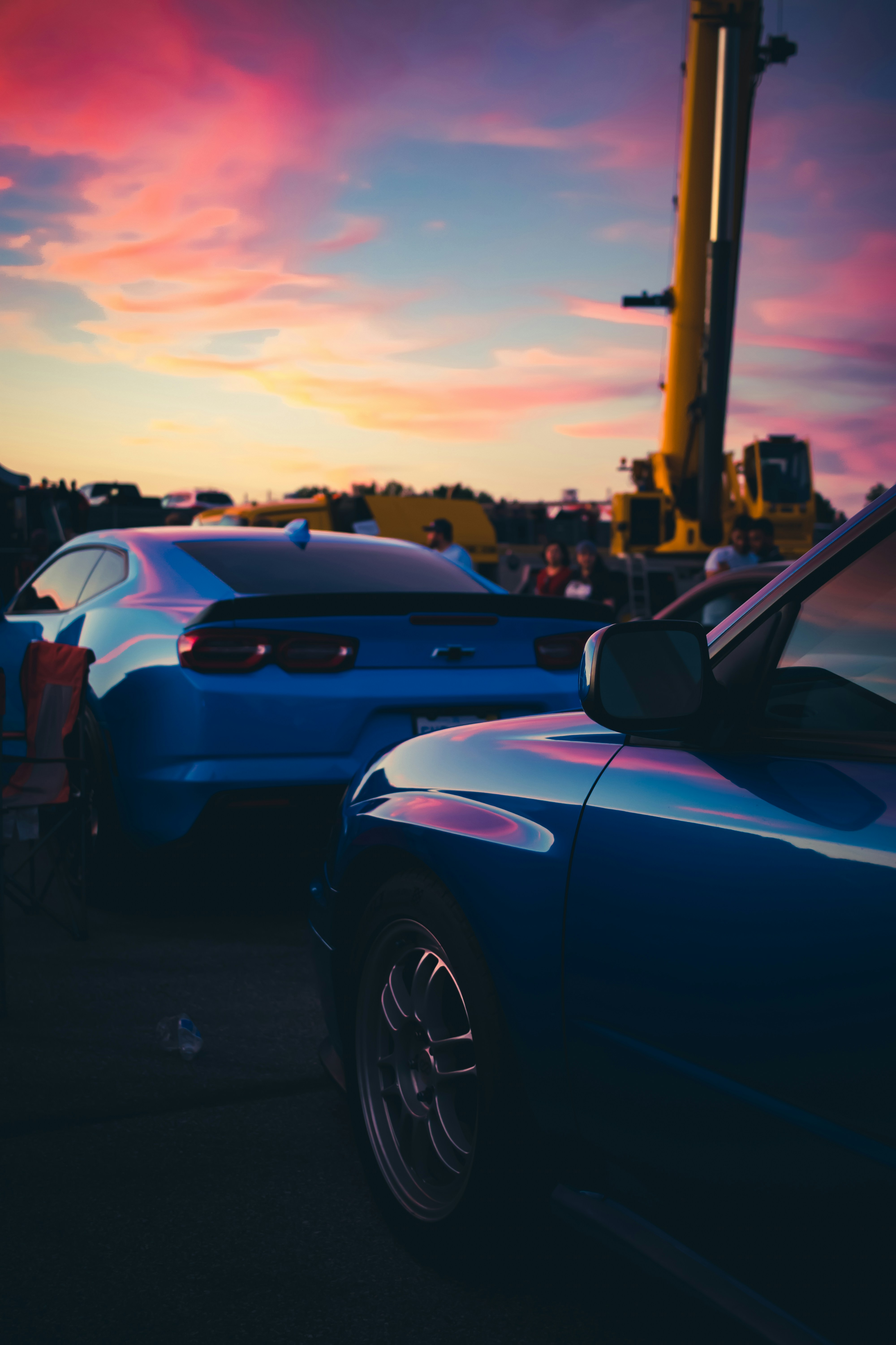 Sunset in the Pit Lane: Blue Cars and Windowsill Light