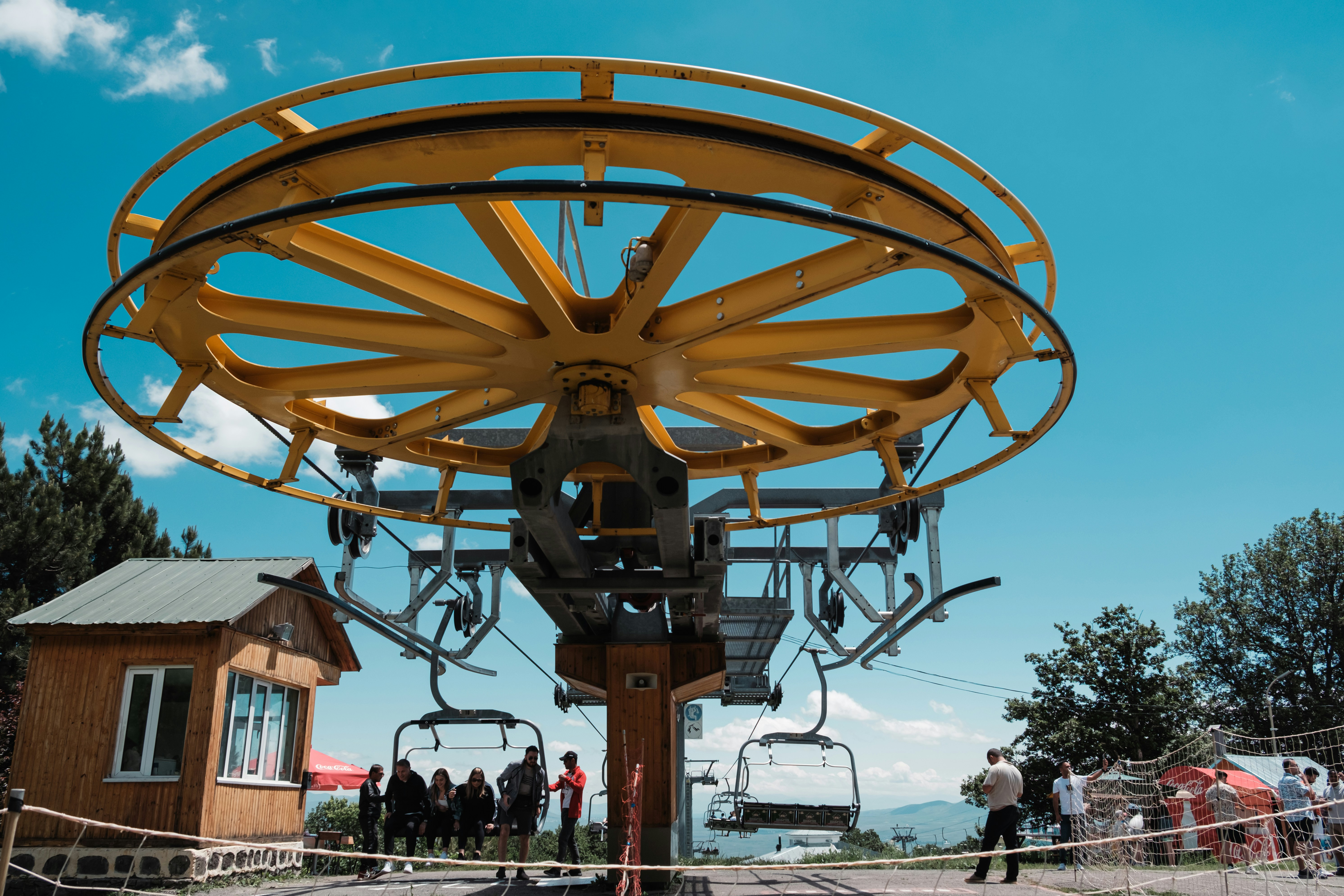 Ringed Summit Wheel in Gold: A Chairlift Scene Under Crystal Sky