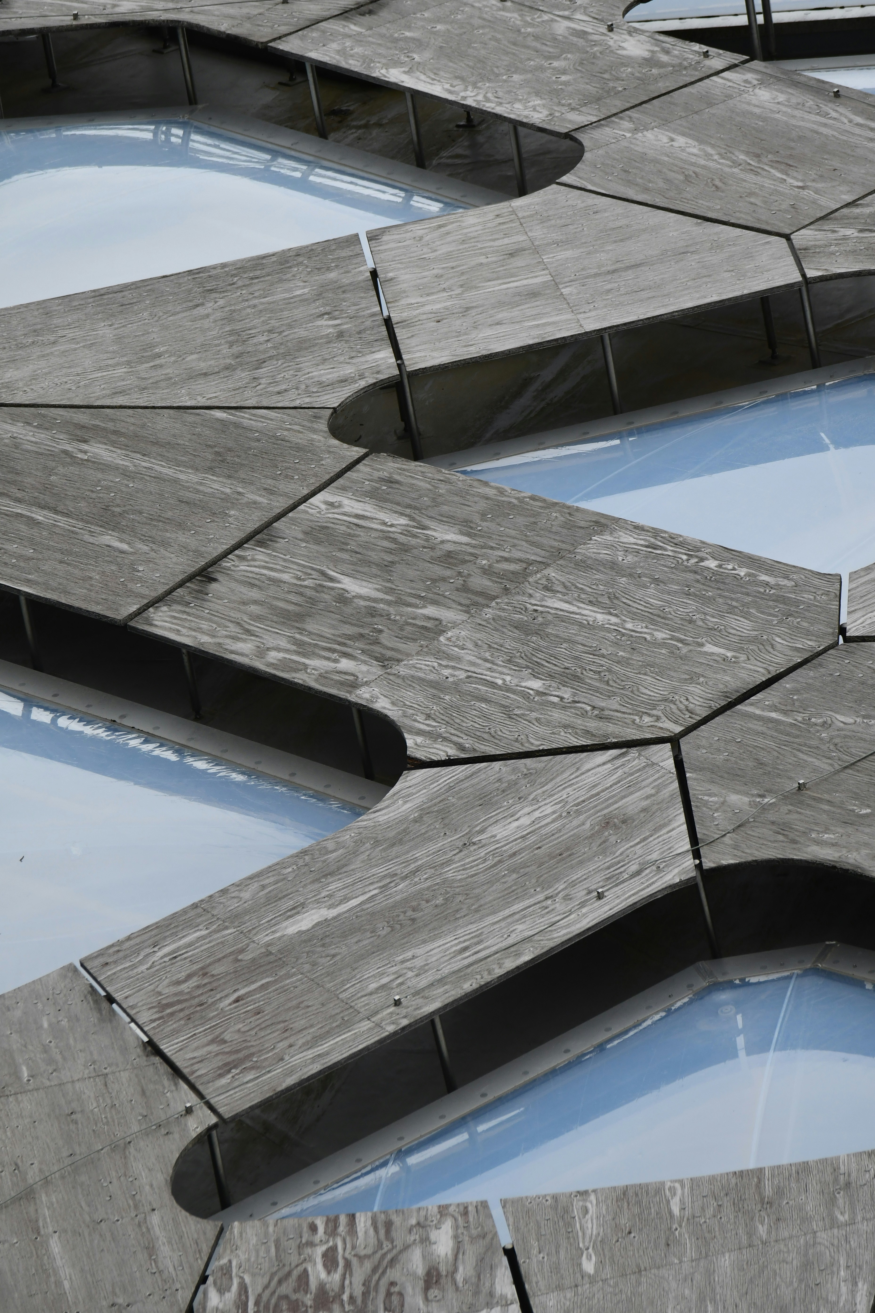 Interlocking Concrete Slabs Over Reflective Glass Pools