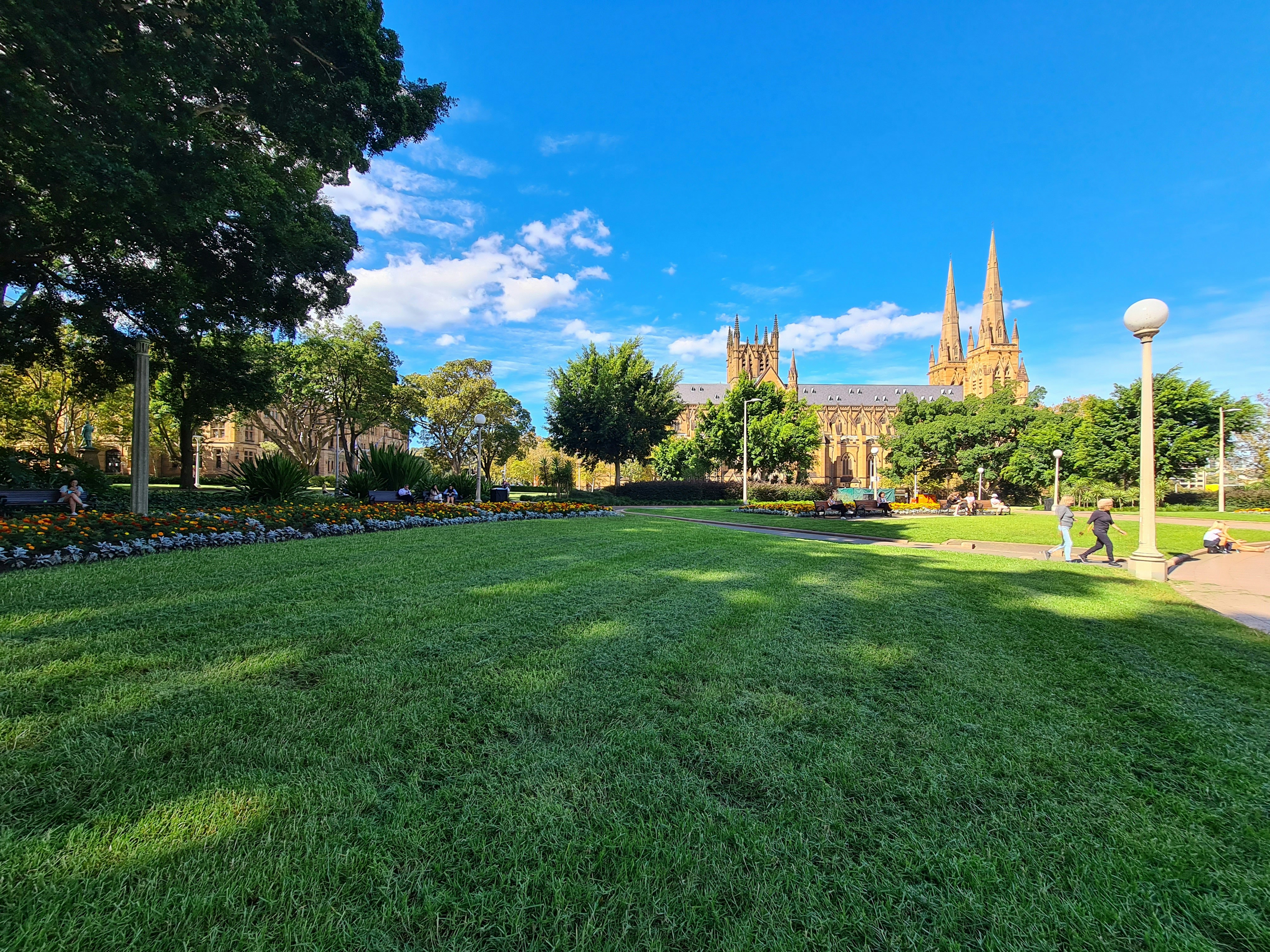Cathedral Silhouette over a Sunlit University Park