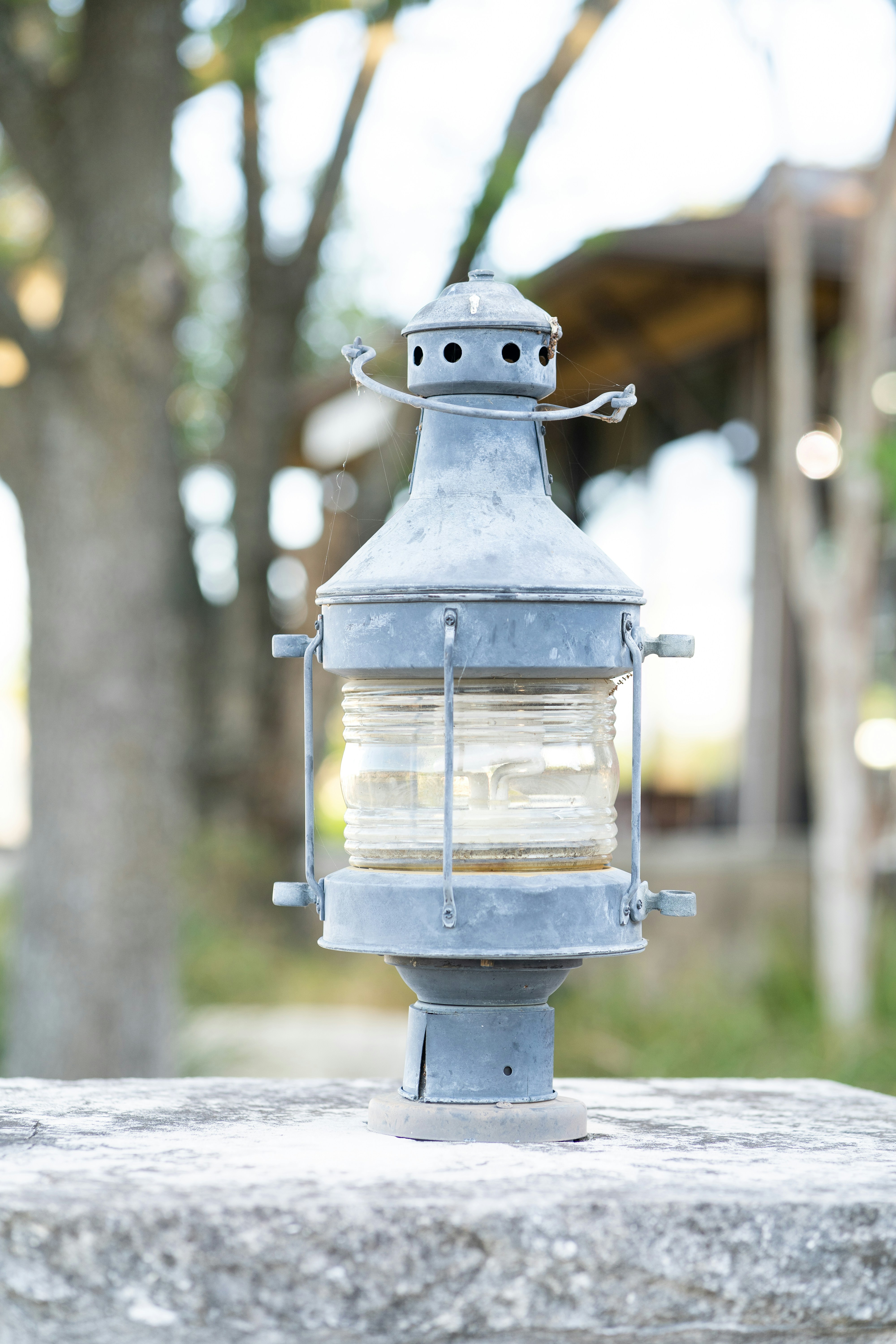 Lantern at Rest: A Weathered Beacon in the Garden