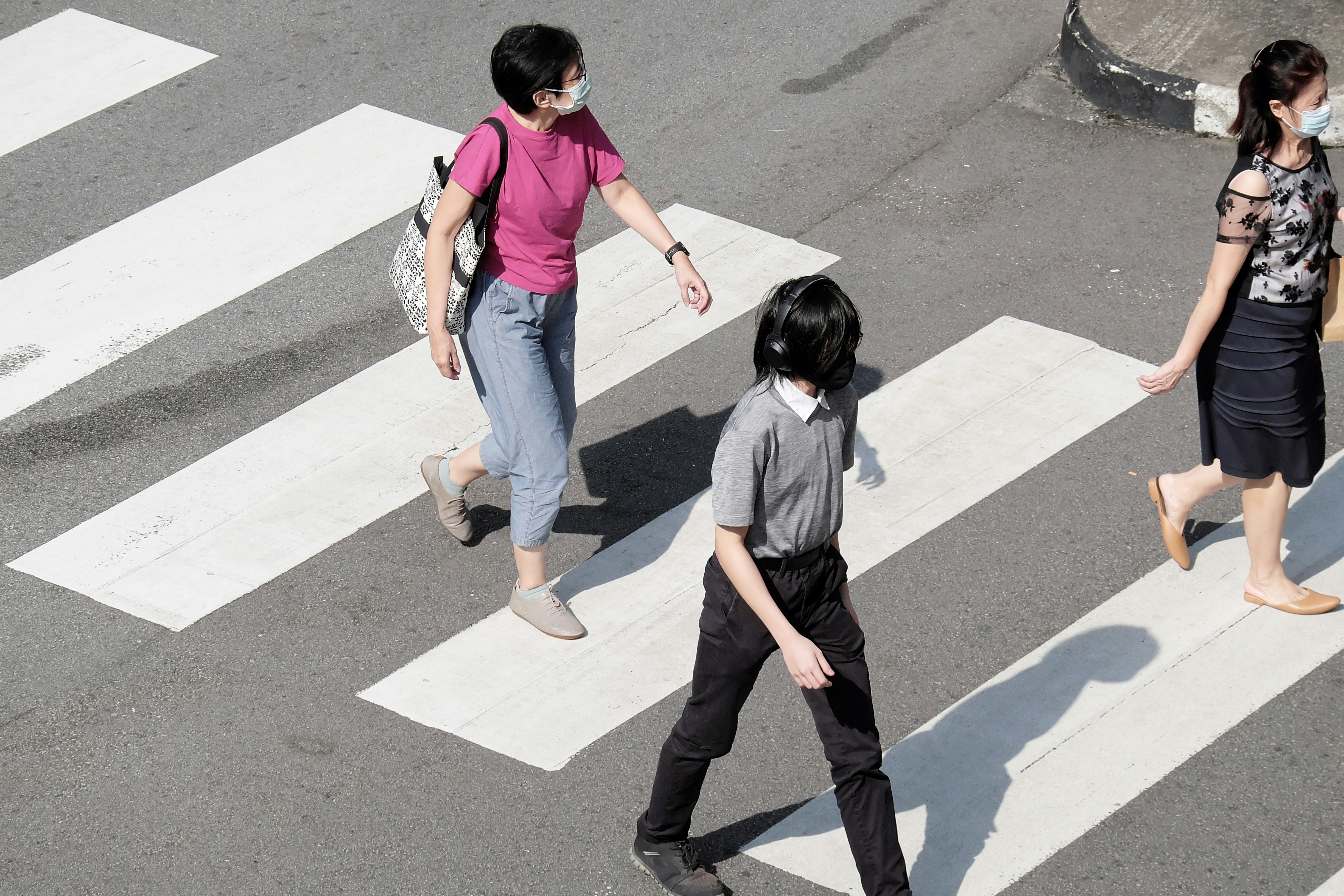 A group of people walking across a crosswalk photo – Free Human Image ...