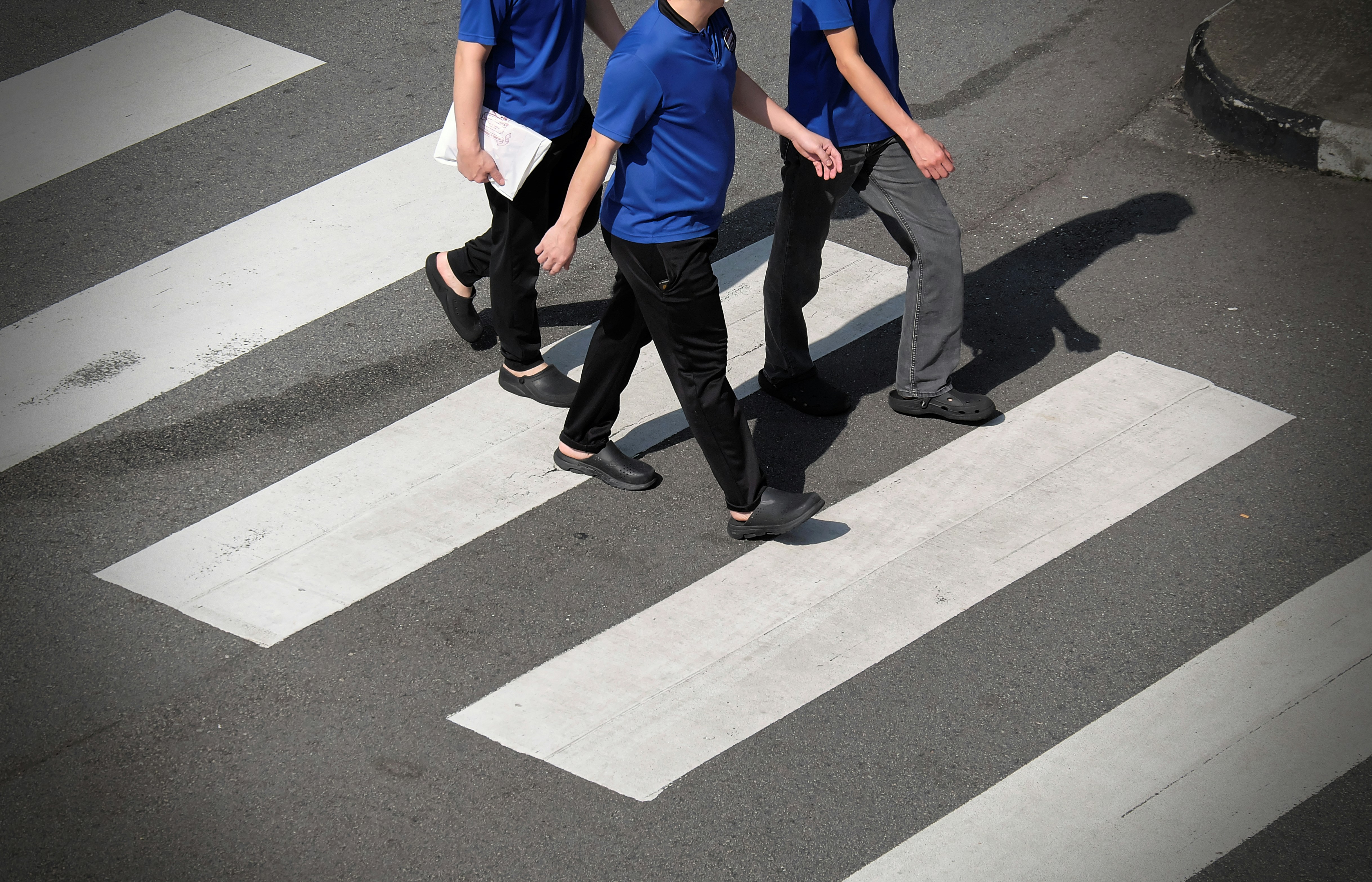 A group of people walking across a crosswalk photo – Free Human Image ...