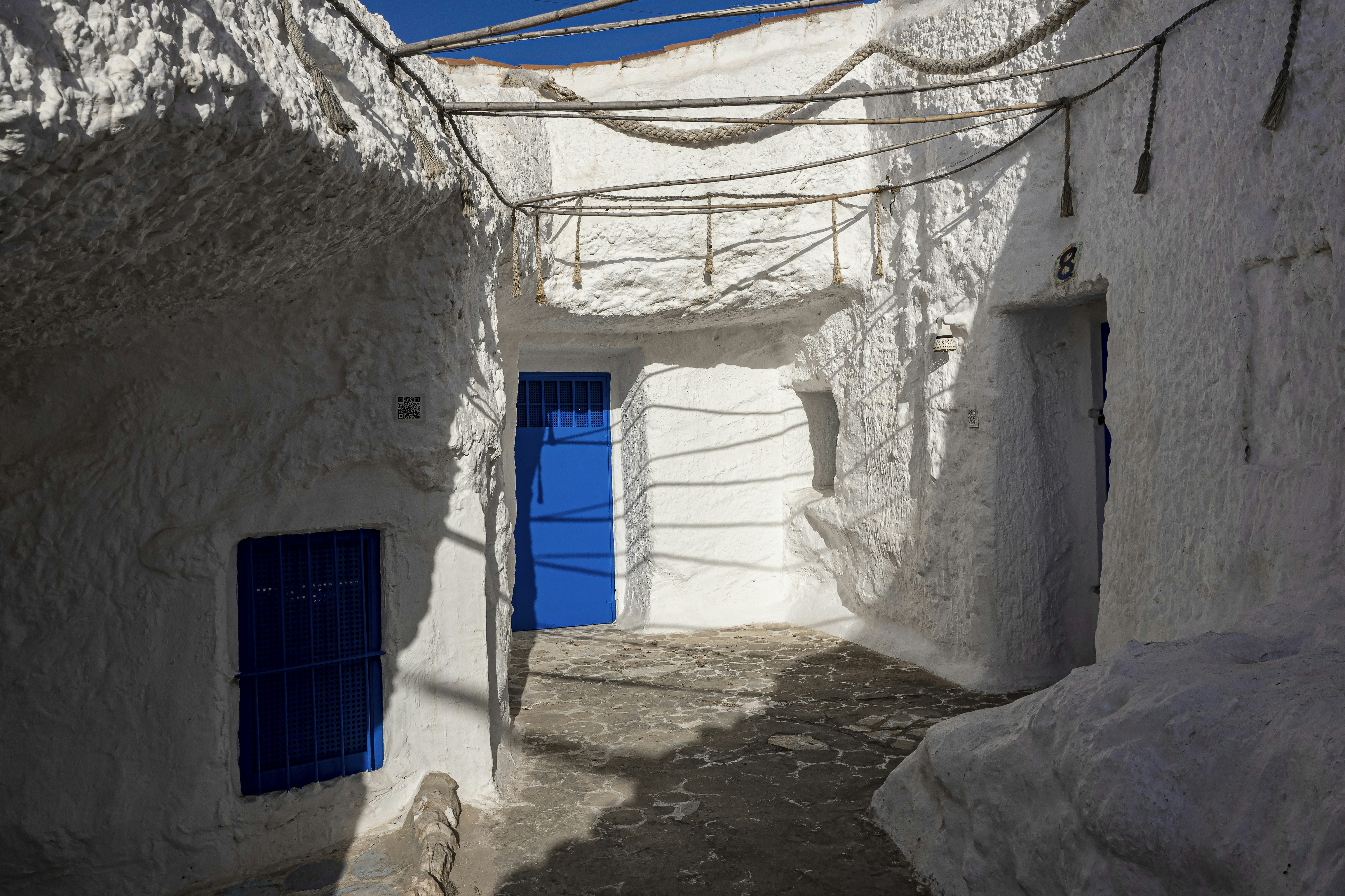 A narrow alley between two stone buildings photo – Free España Image on ...