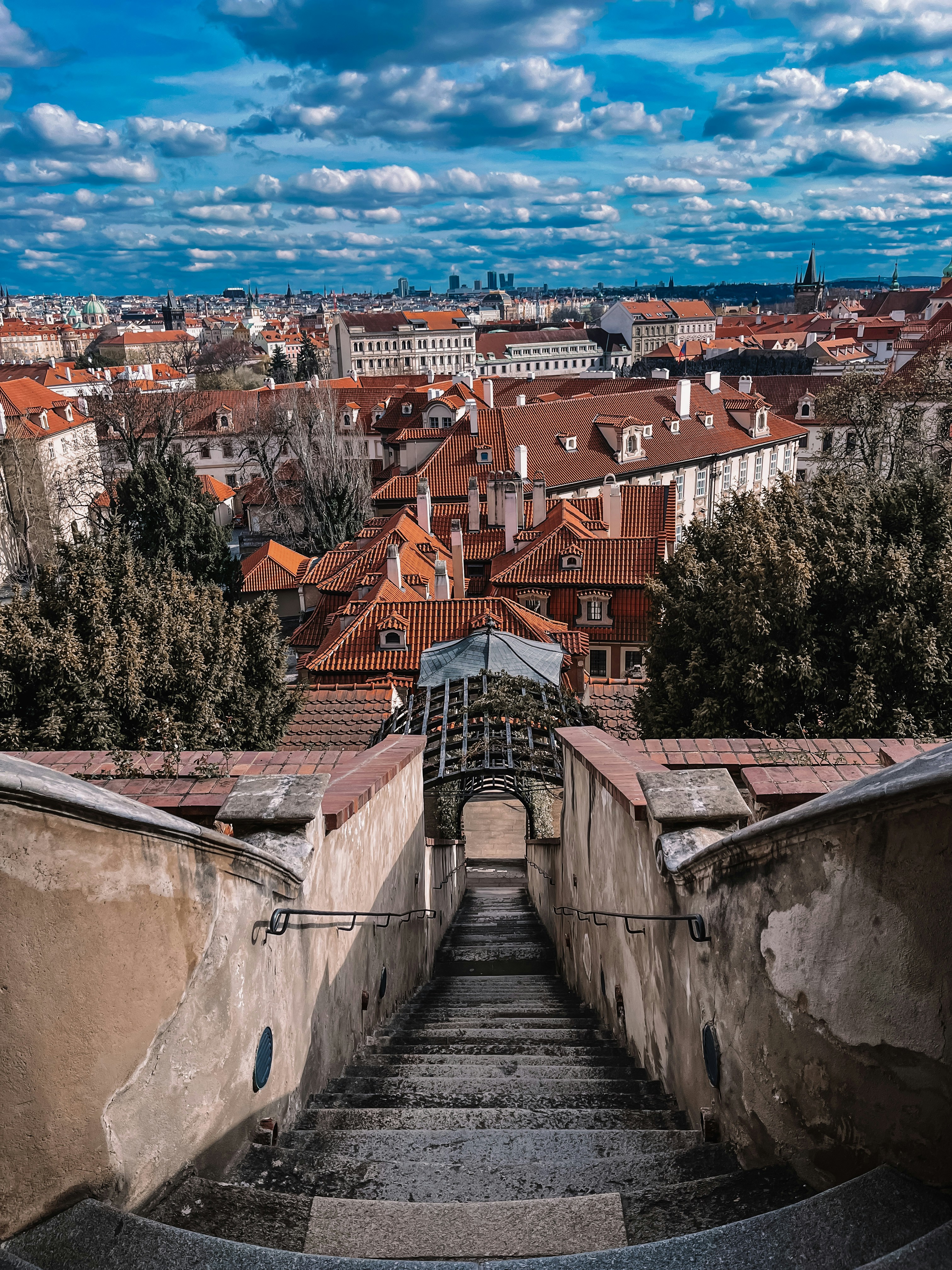 Staircase Descent into a Sea of Red Tile Roofs