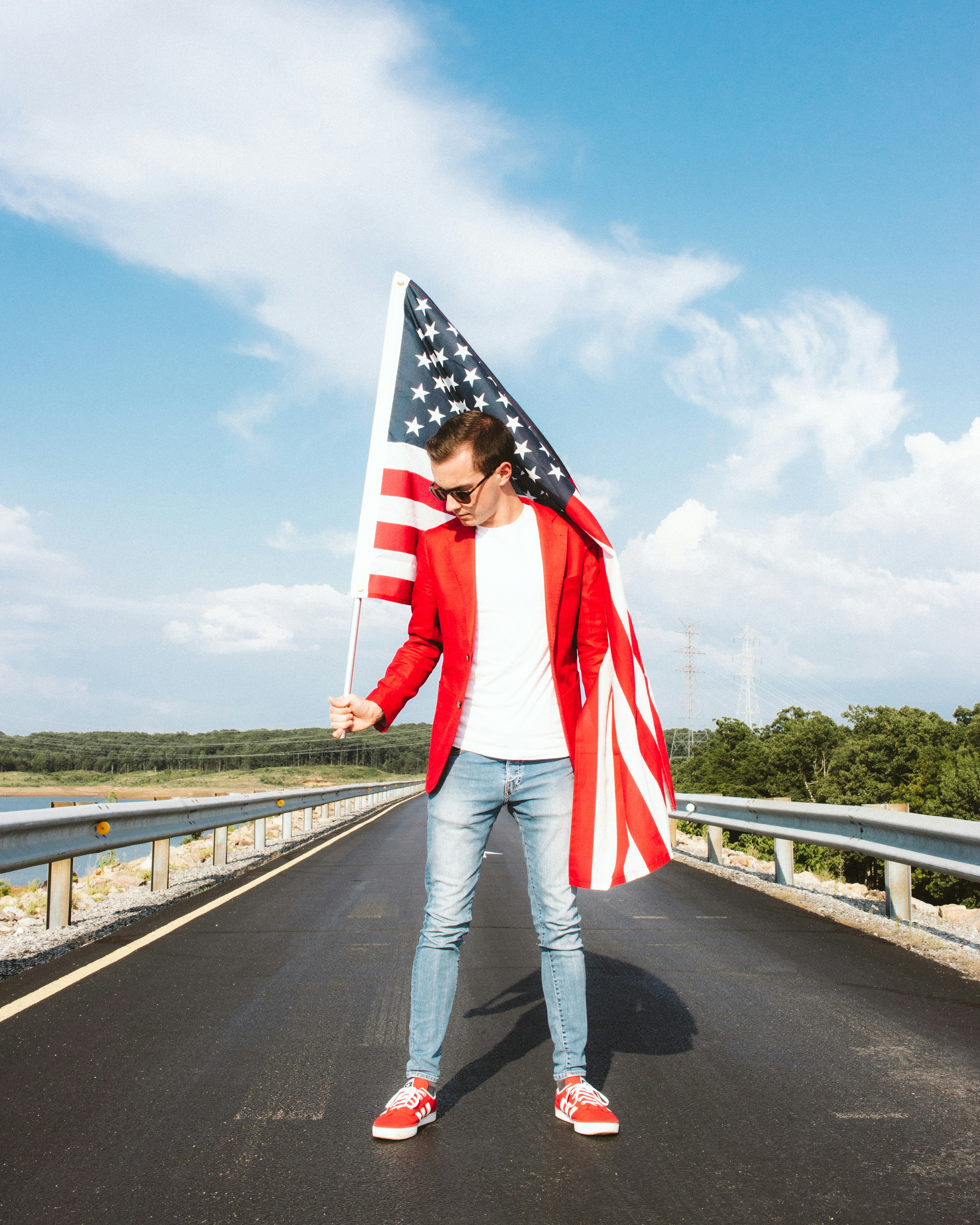 Flag on the Asphalt: A Solo Portrait on a Quiet Bridge