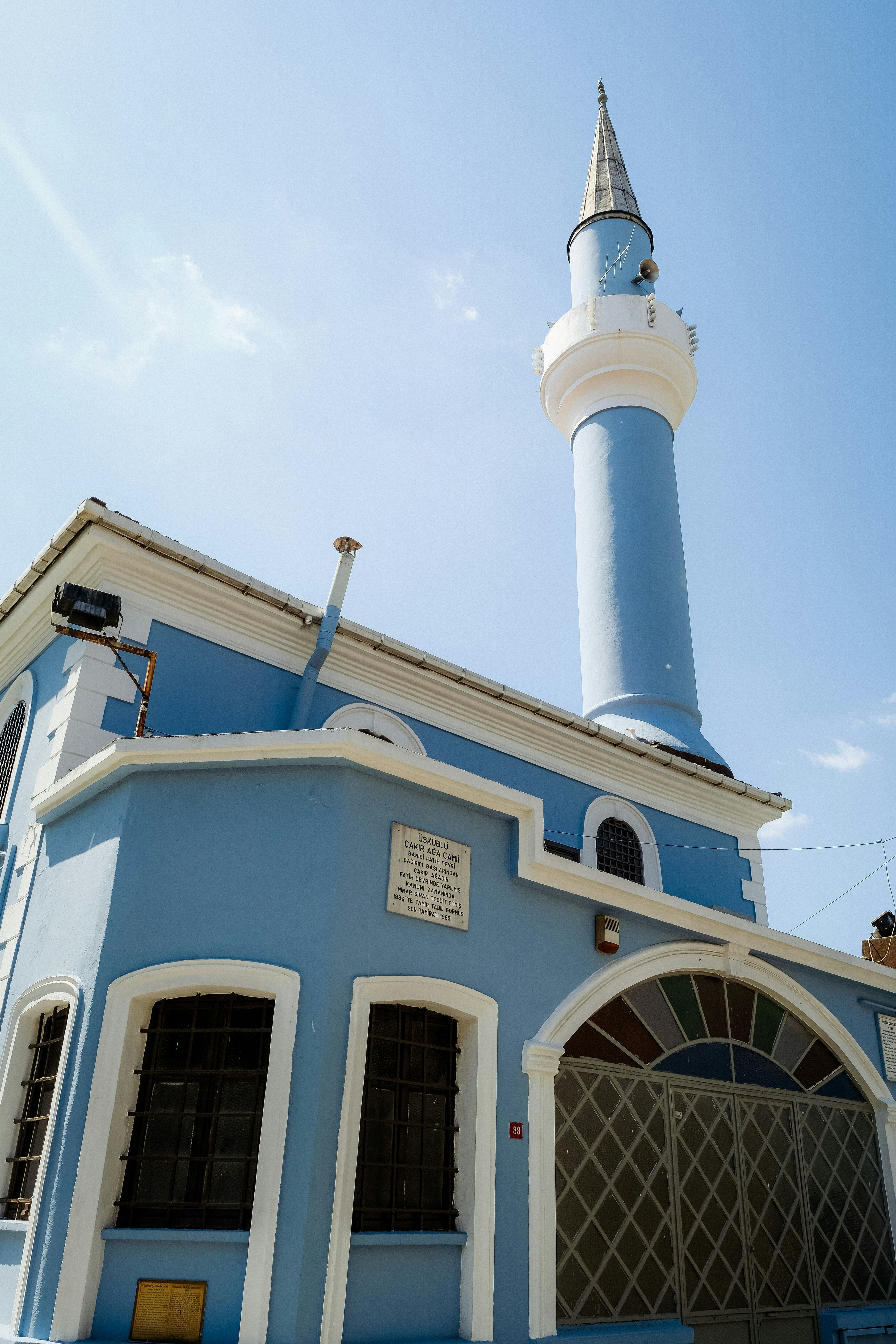 Azure Minaret Reaches Toward the Sky Over a Cerulean Mosque Facade