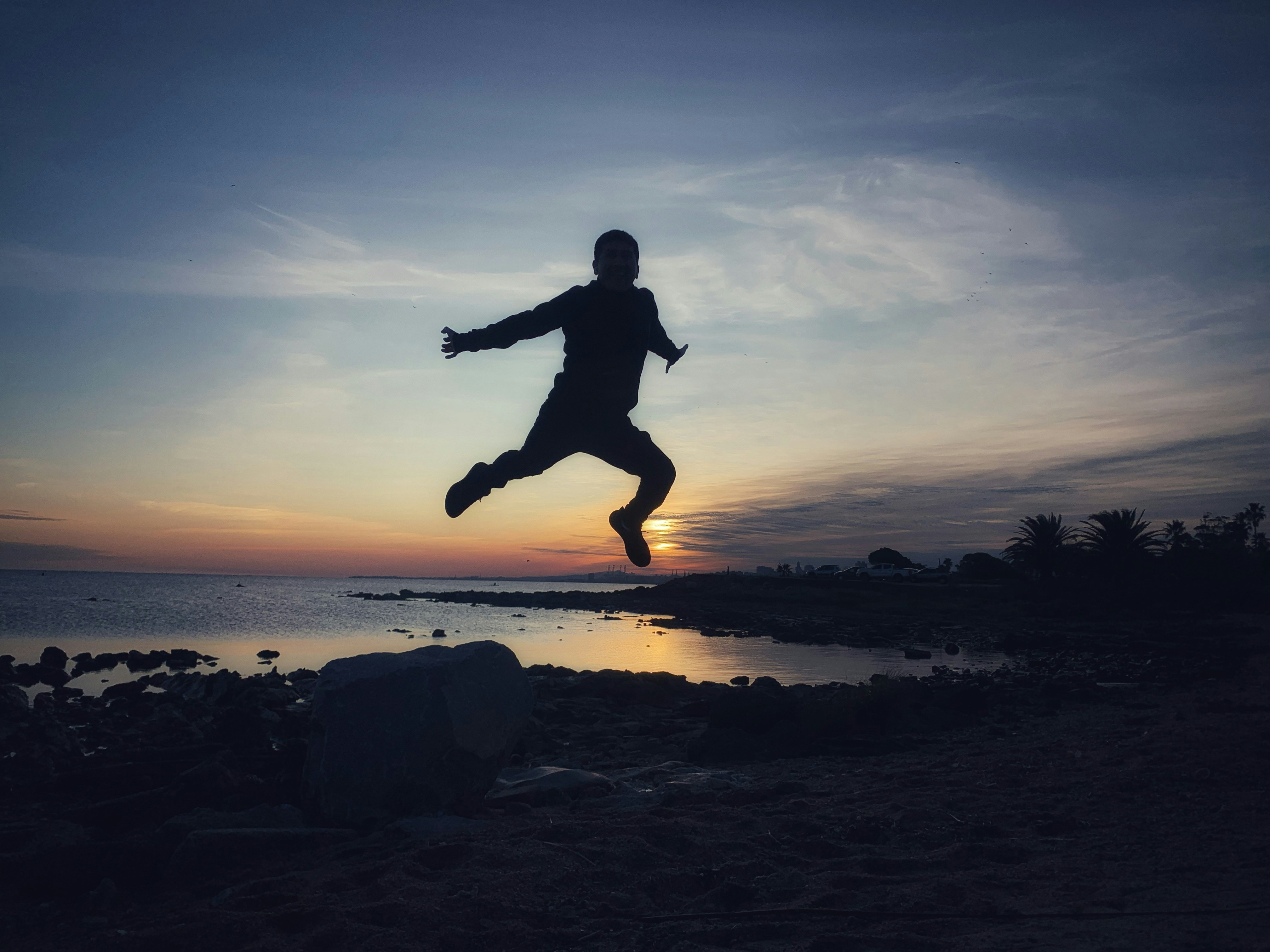 A man jumping over rocks photo – Free Person Image on Unsplash