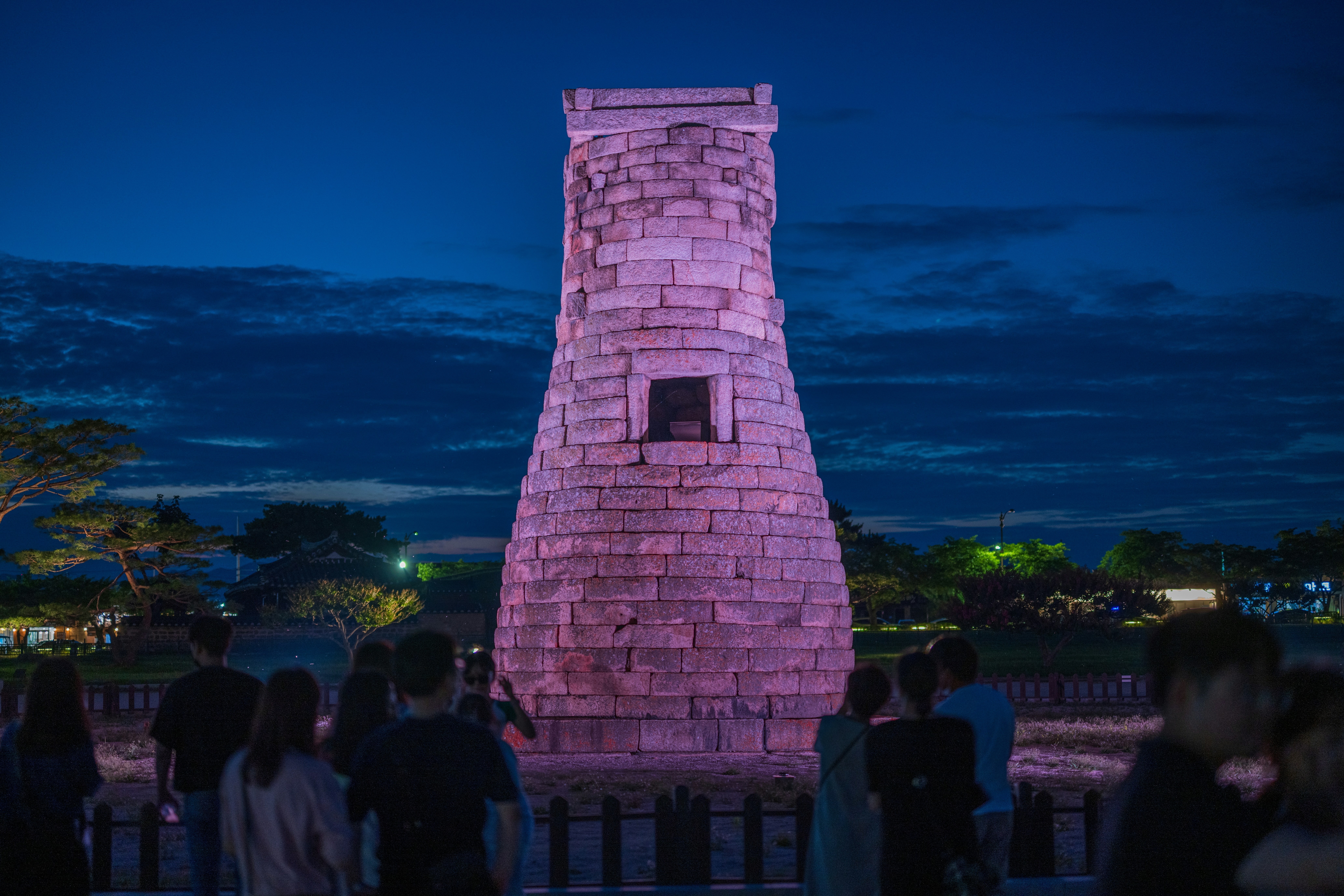 A group of people standing around a tall tower photo – Free Gyeongju ...