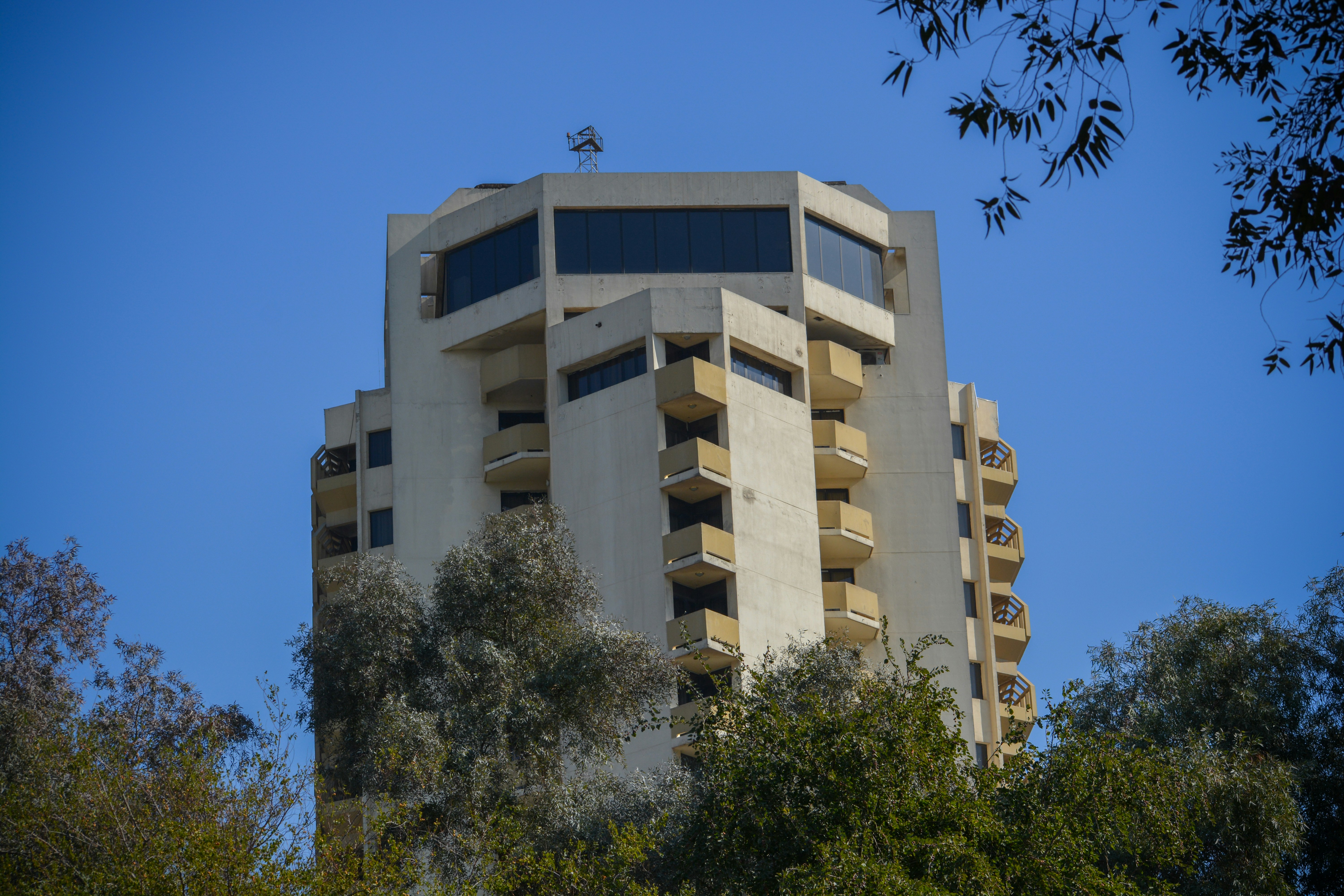 A tall building with trees in front of it photo – Free Baghdad Image on ...