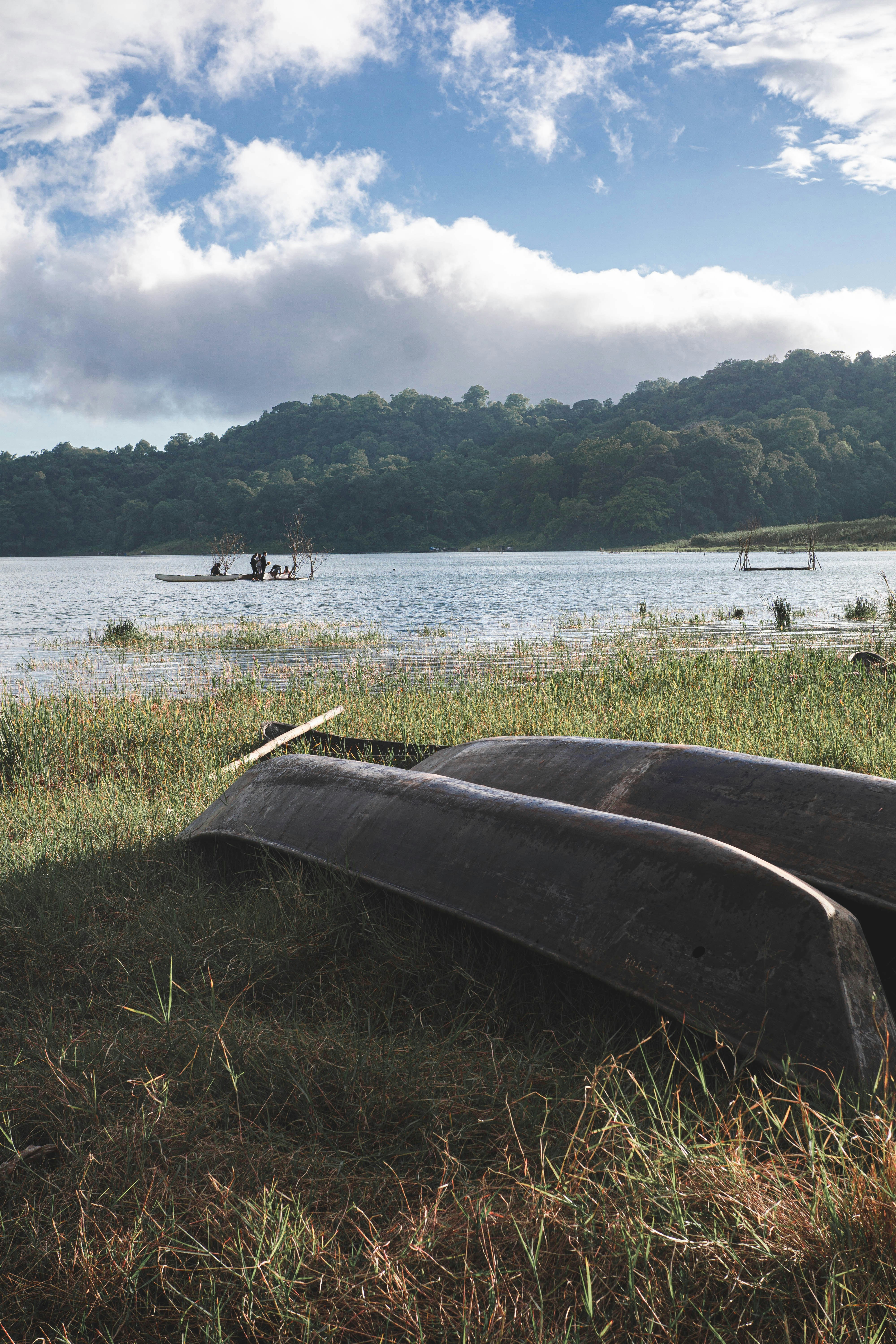 Quiet Lake, Small Crew: Canoe Drift Beneath a Cloudy Sky