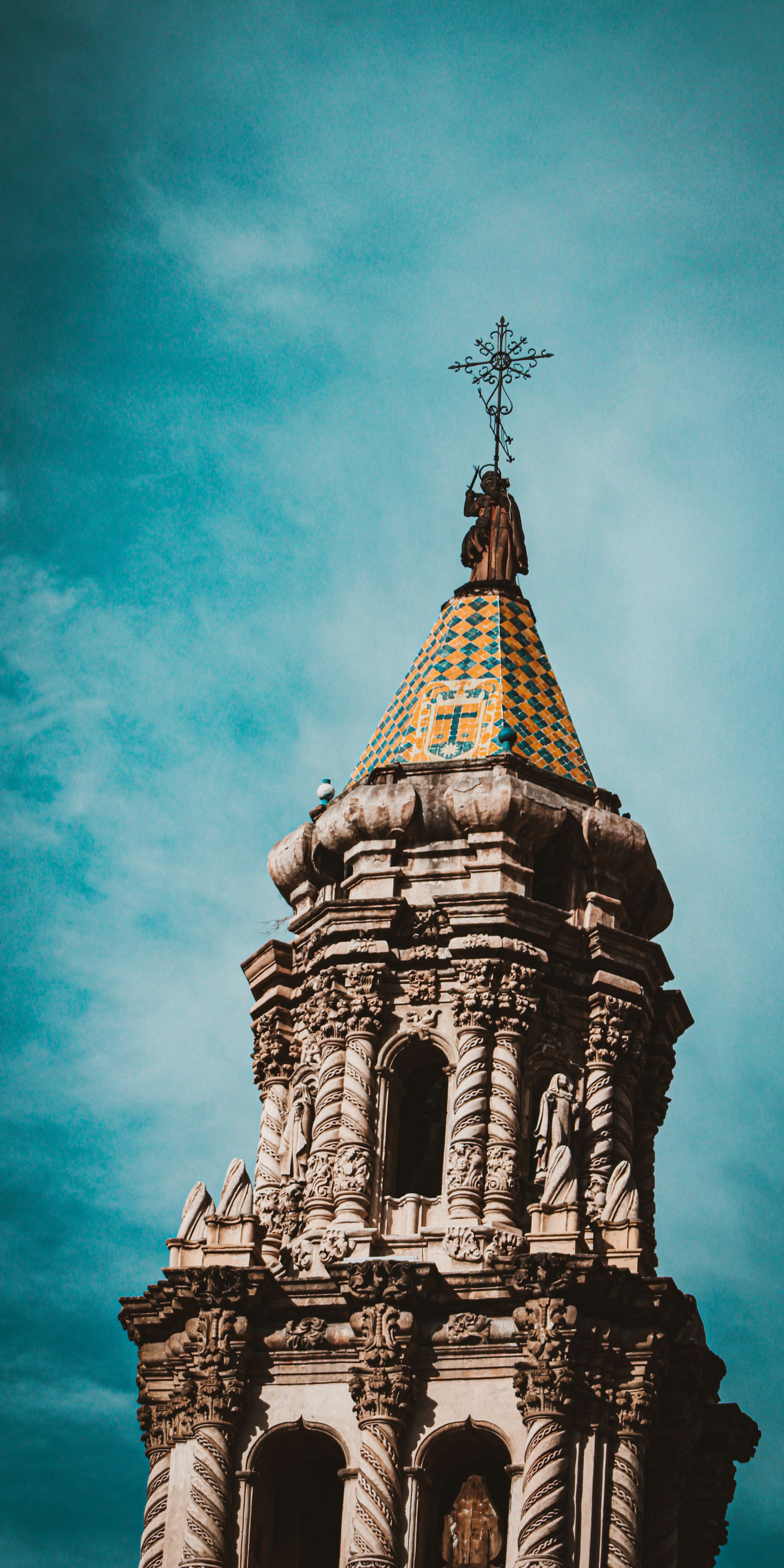 A tall building with a cross on top photo – Free Blue Image on Unsplash