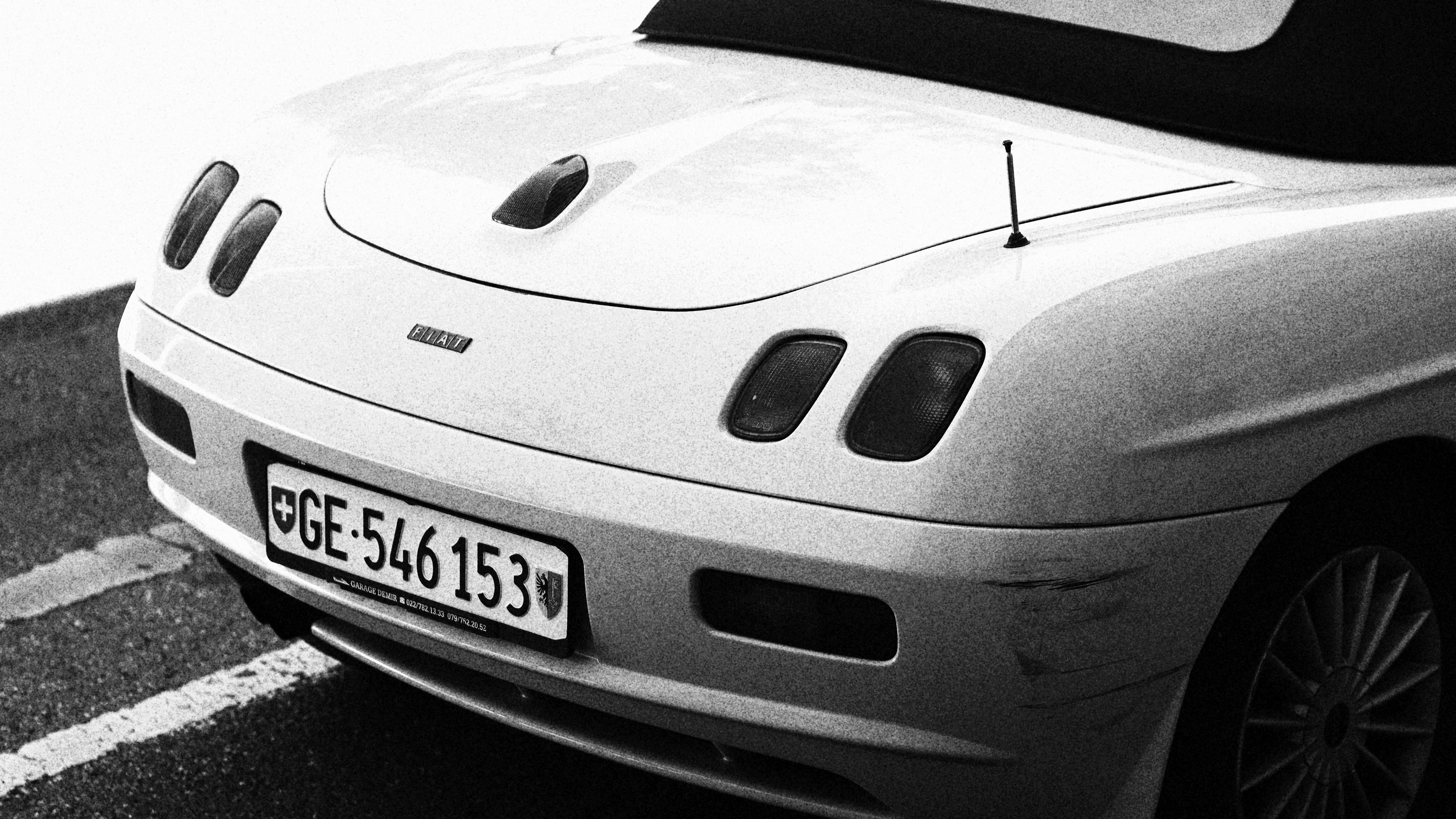 Monochrome Front-End Portrait of a Droptop Convertible: License Plate and Round Headlights