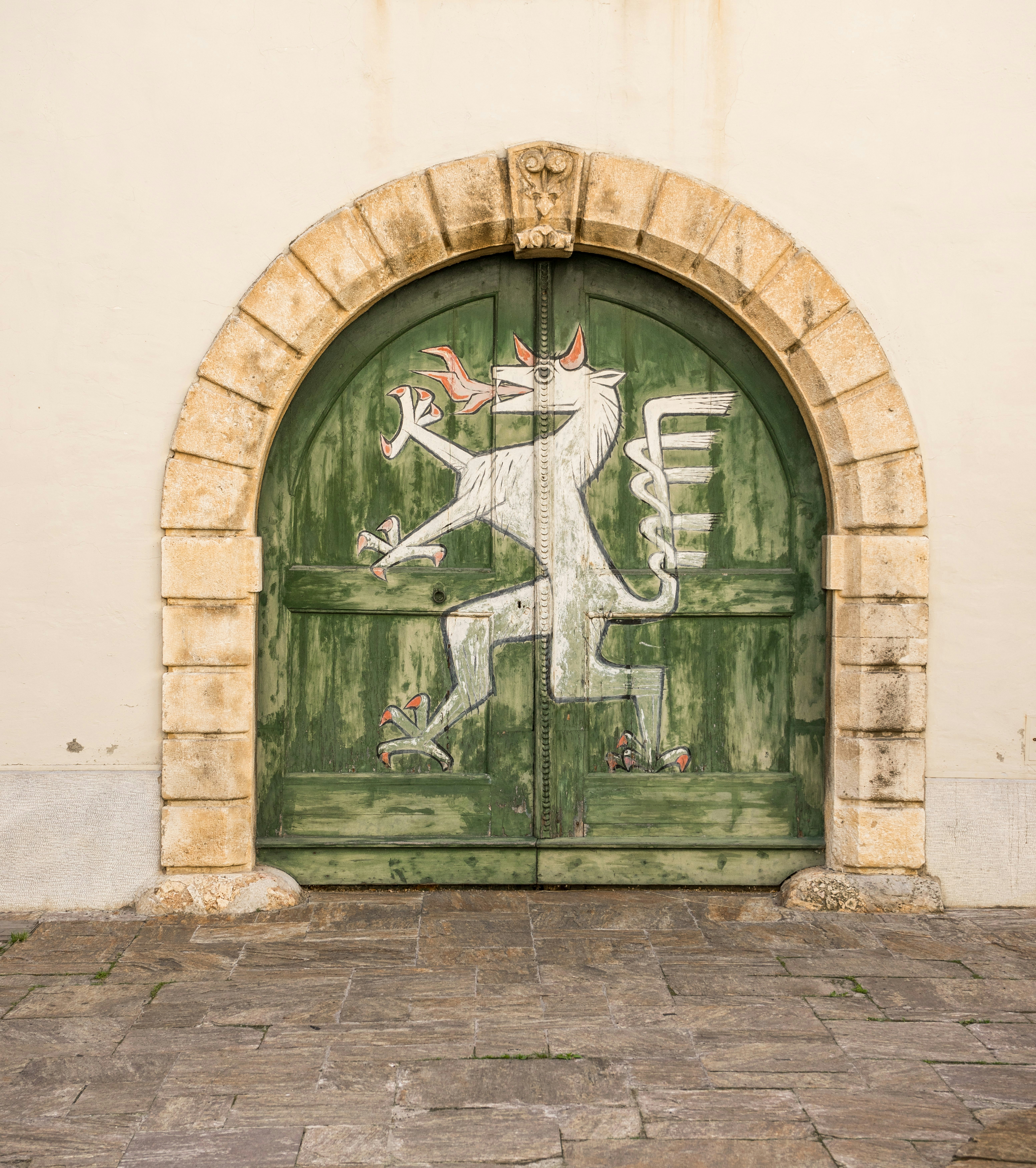 Green Portal with a Grimacing Wolf: An Arched Doorway with Weathered Character