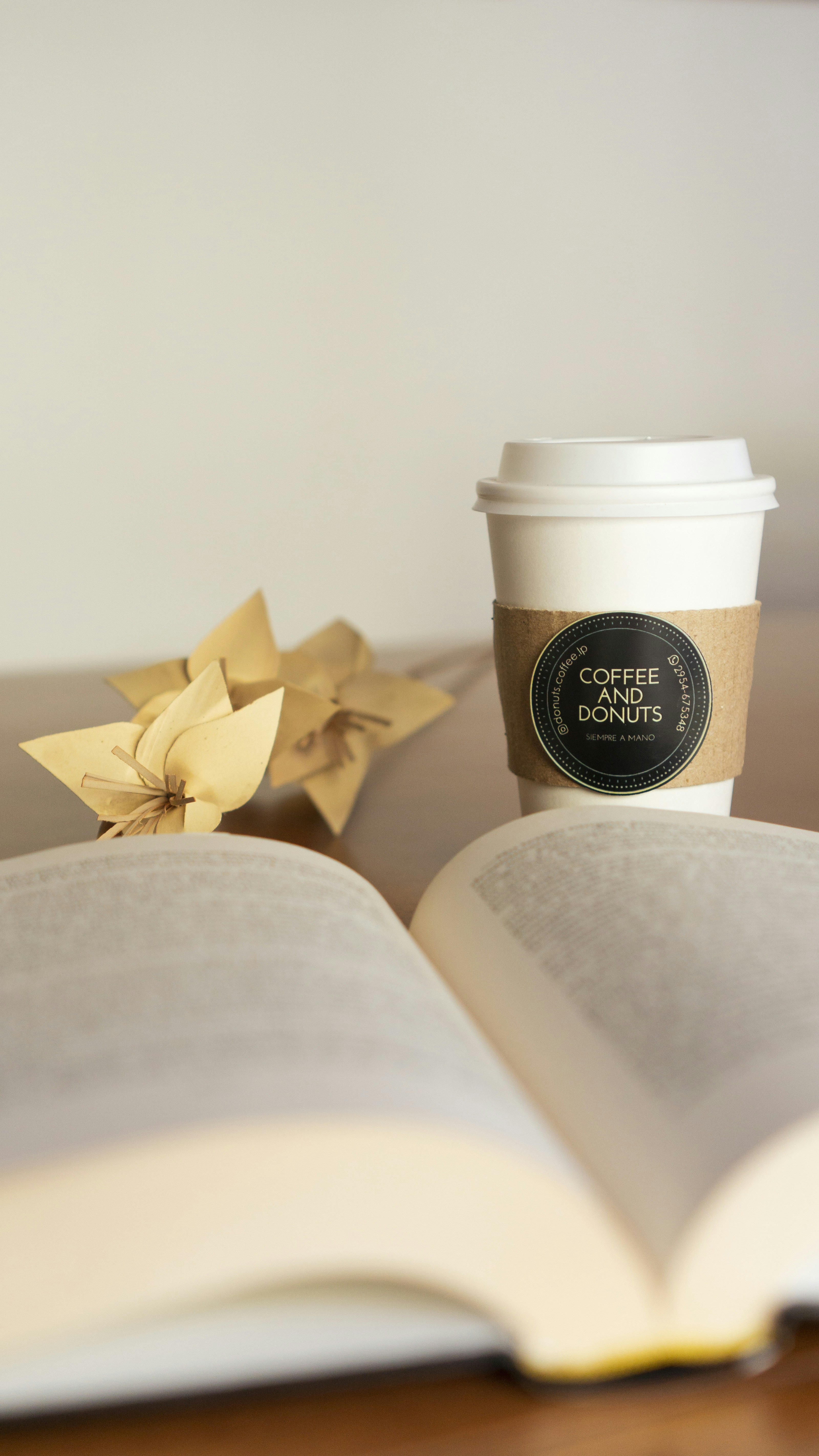 Sip and Script: A Coffee Cup Beside an Open Book
