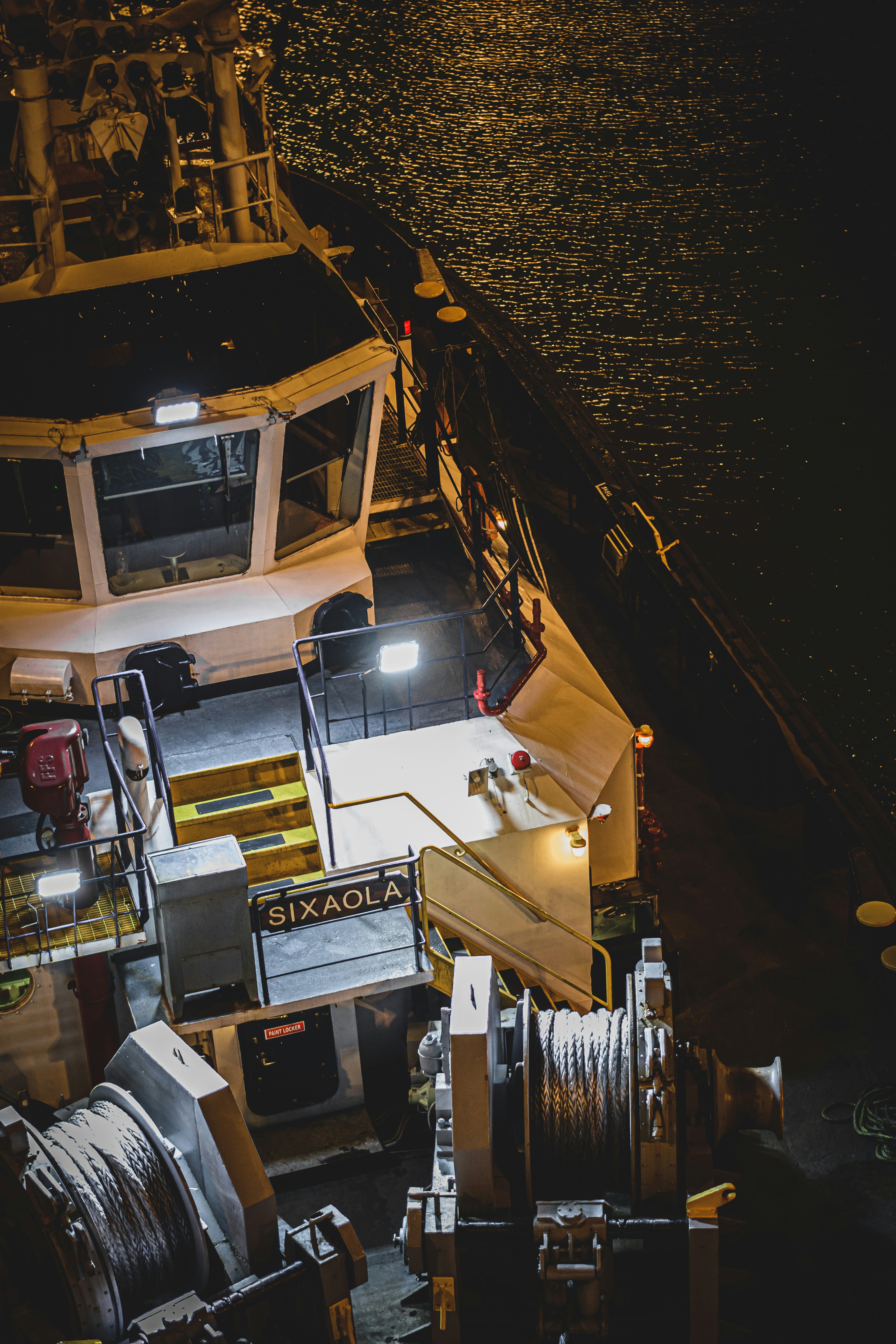 Midnight Ferry Deck: Staircase, Signage, and Winches Under Harbor Glow