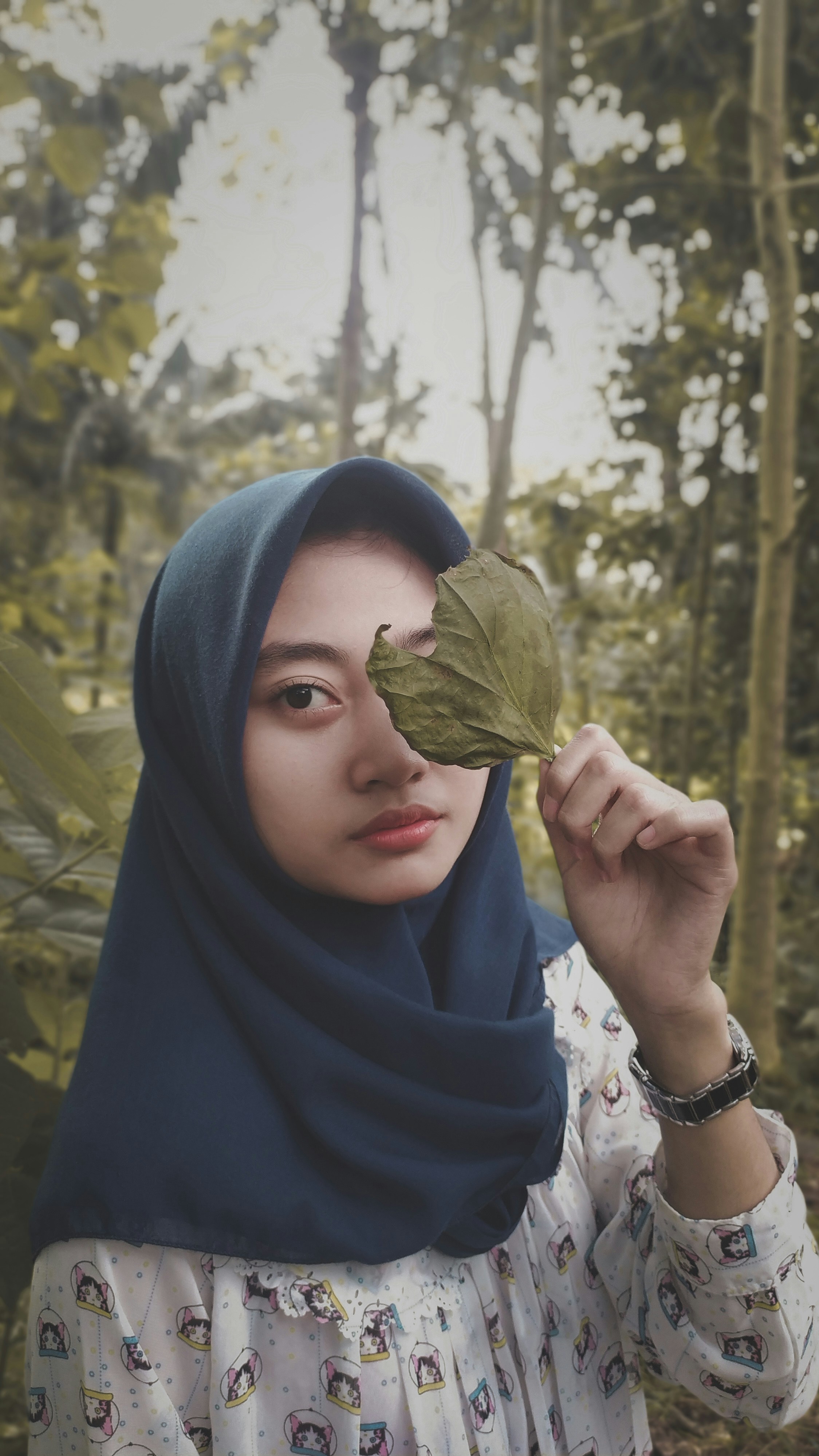 Veil of Blue: A Portrait Beneath Autumn Leaves