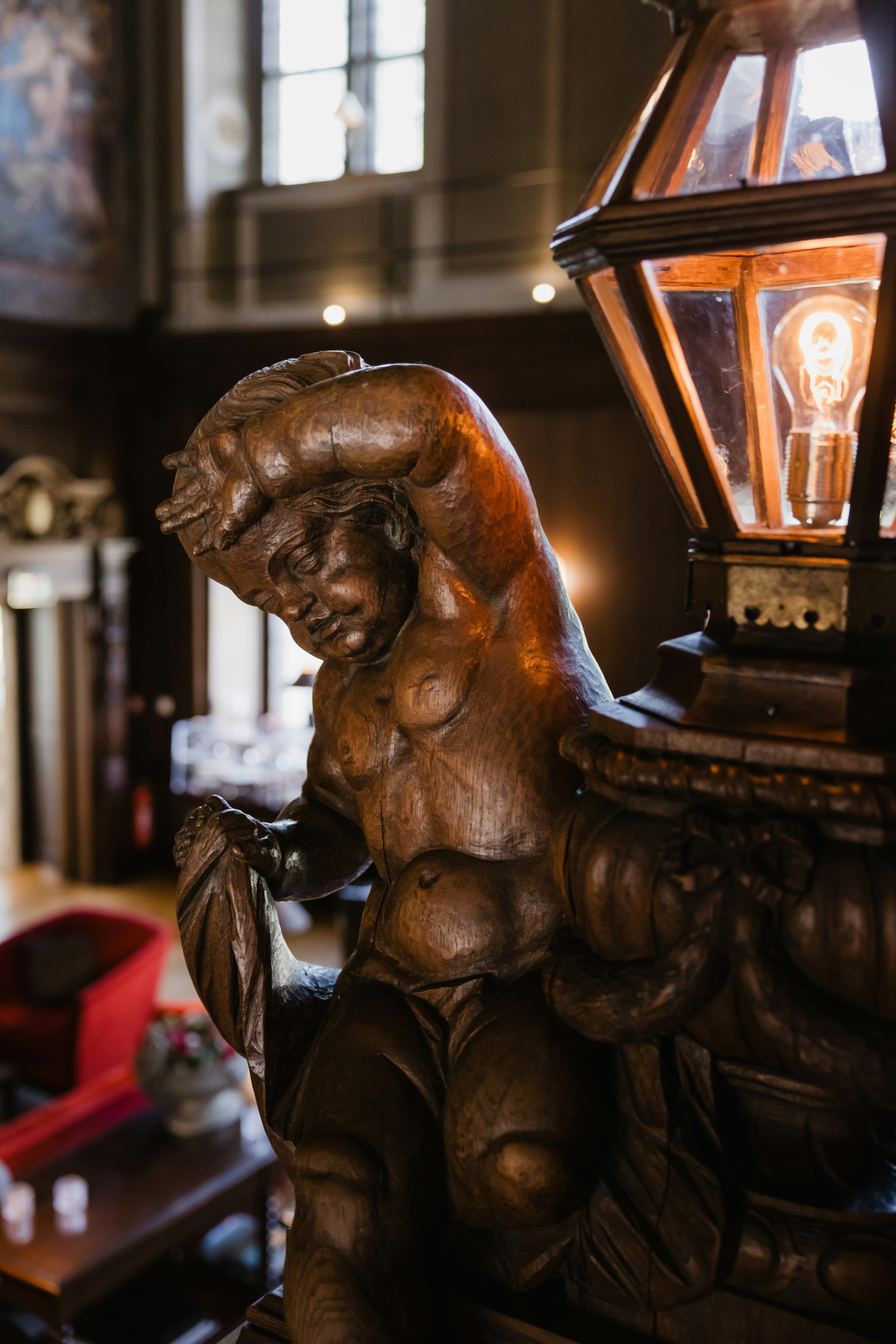 Bronze Figure Bathed in Amber Lantern Light