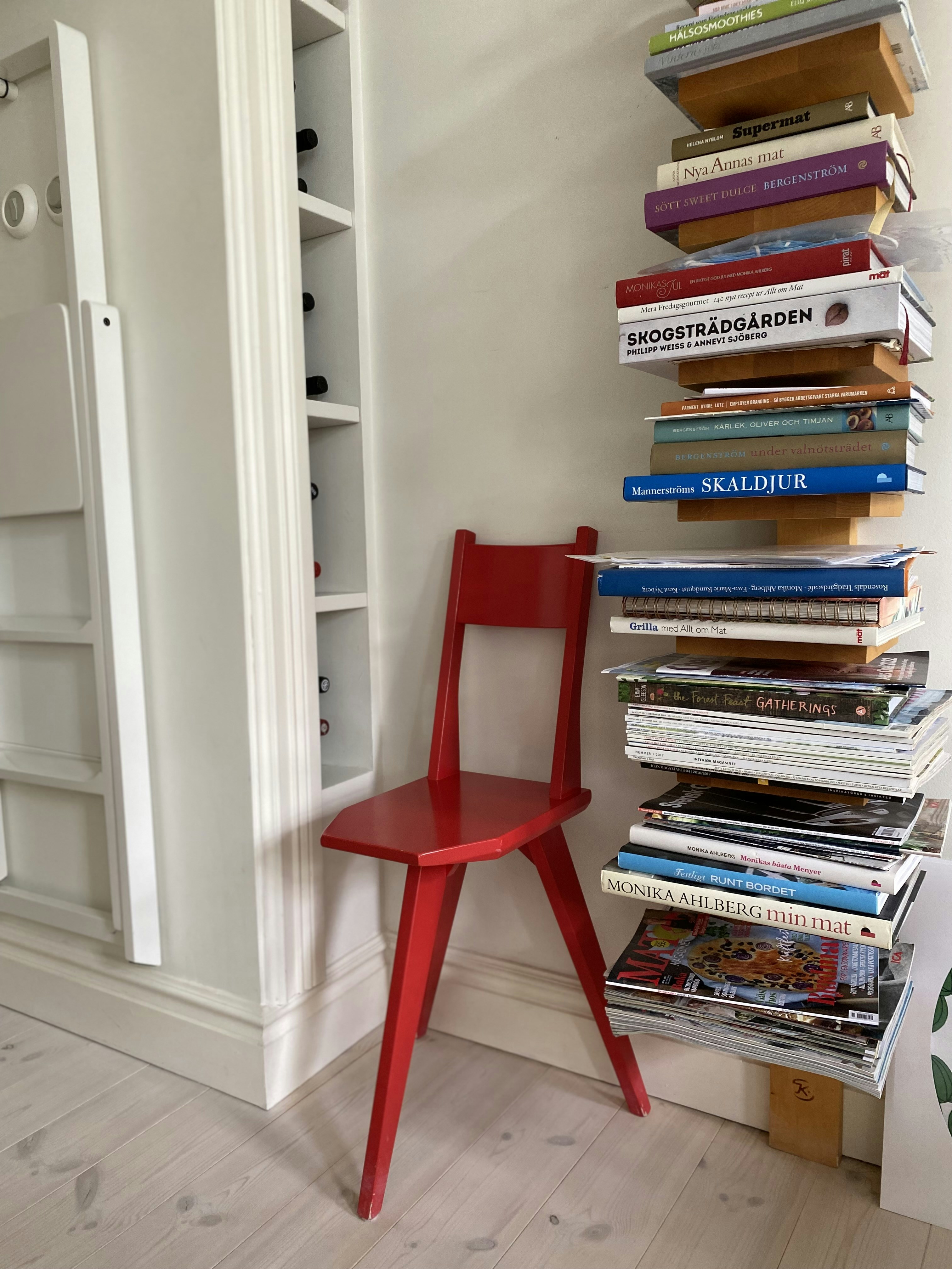 Red Chair Amid a Towering Stack of Books