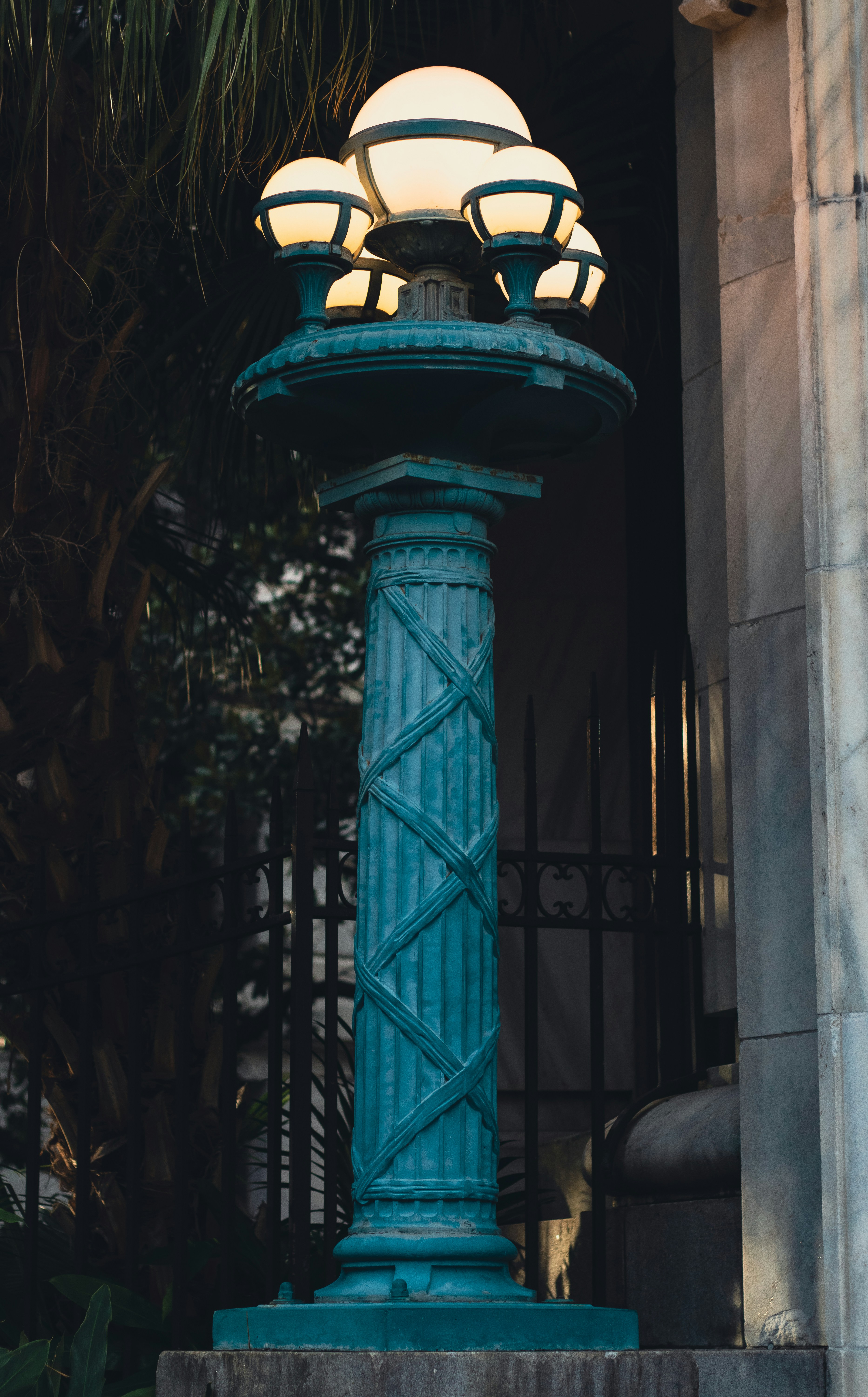 a light post with a blue lamp