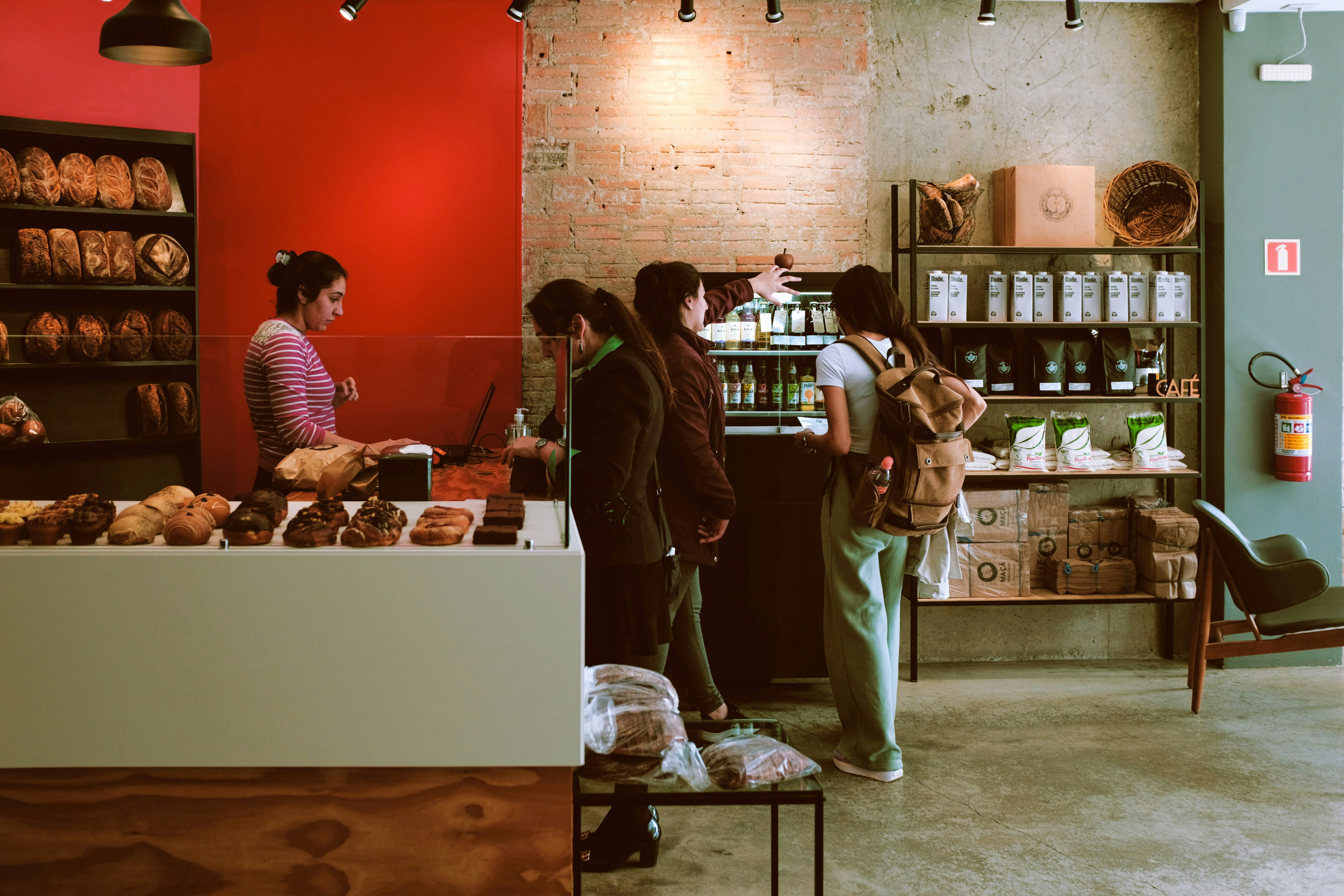 A group of people standing in a bakery photo – Free Human Image on Unsplash