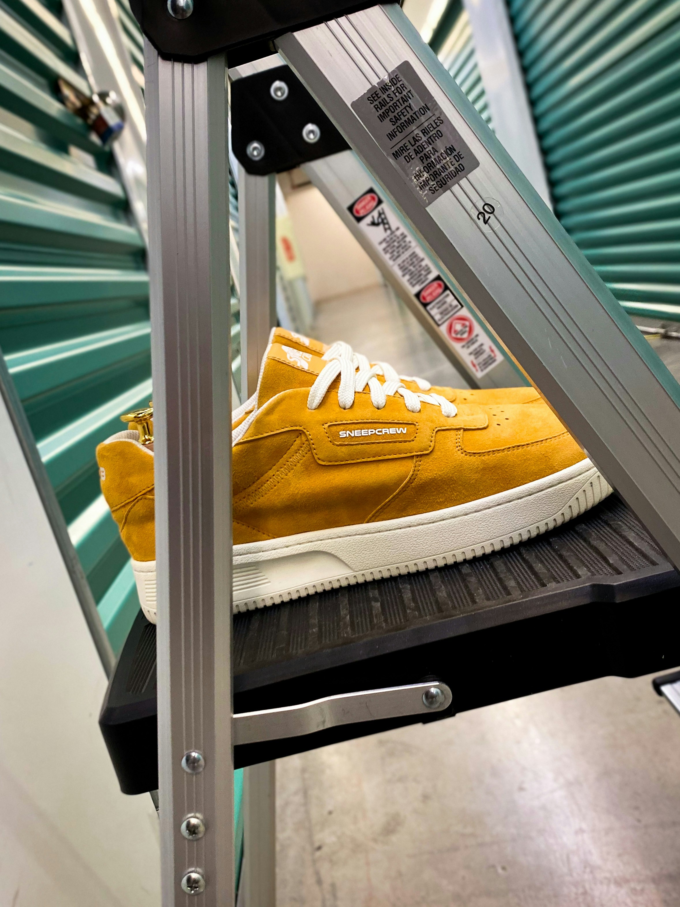 a yellow and black shoe on a metal shelf