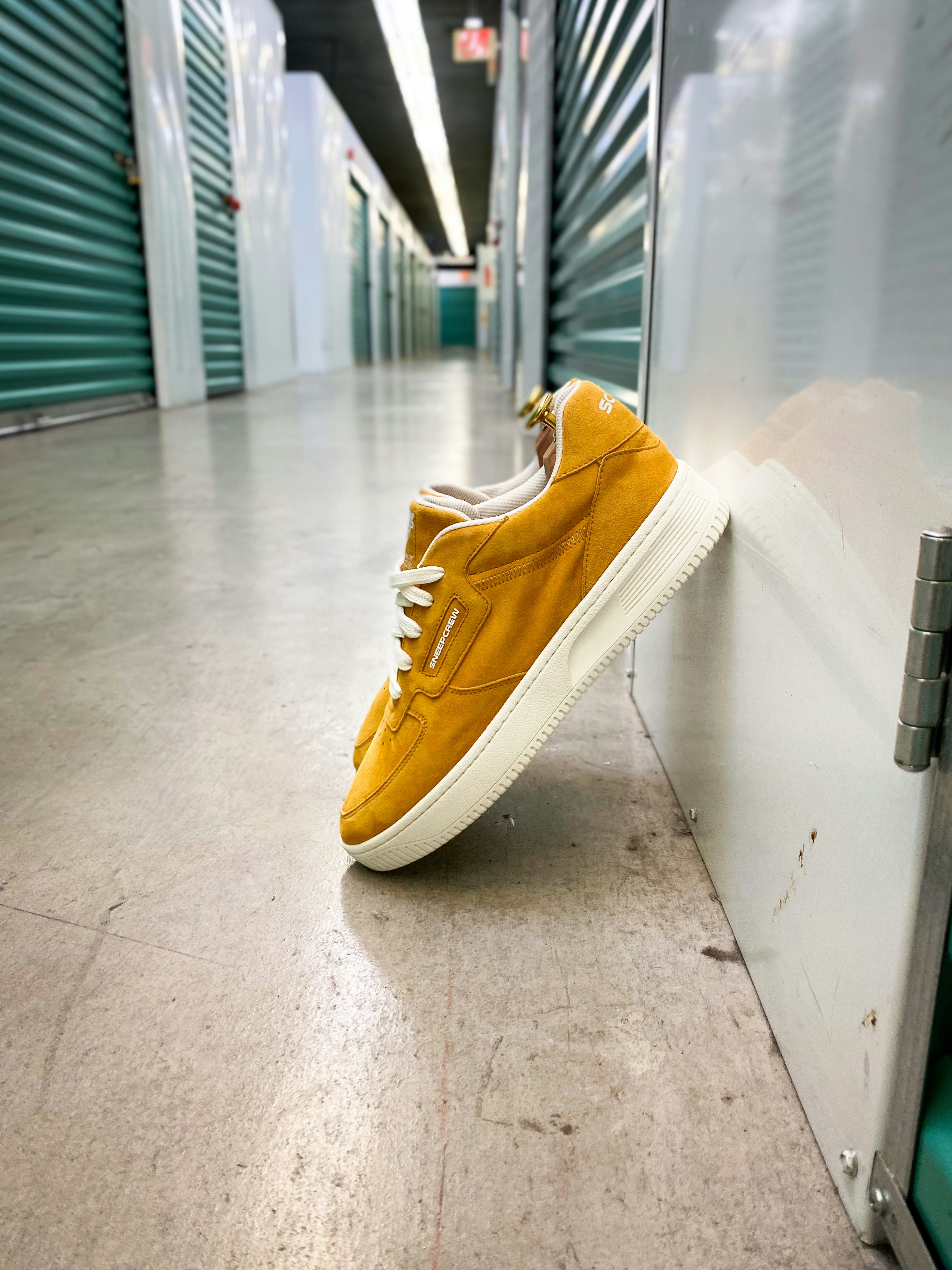 Amber Sneaker Balances Against the Echo of an Industrial Aisle