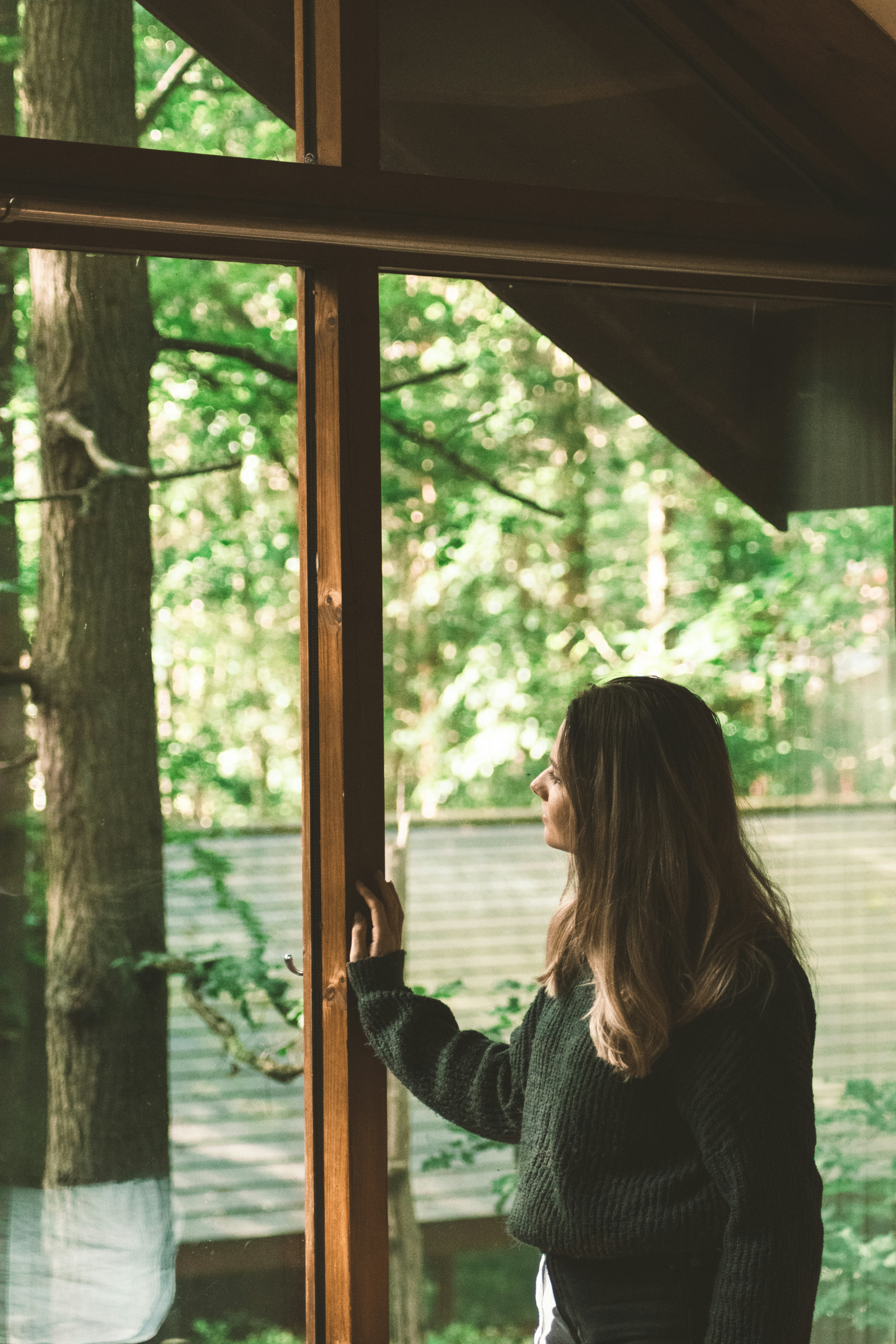 a woman holding a wooden frame