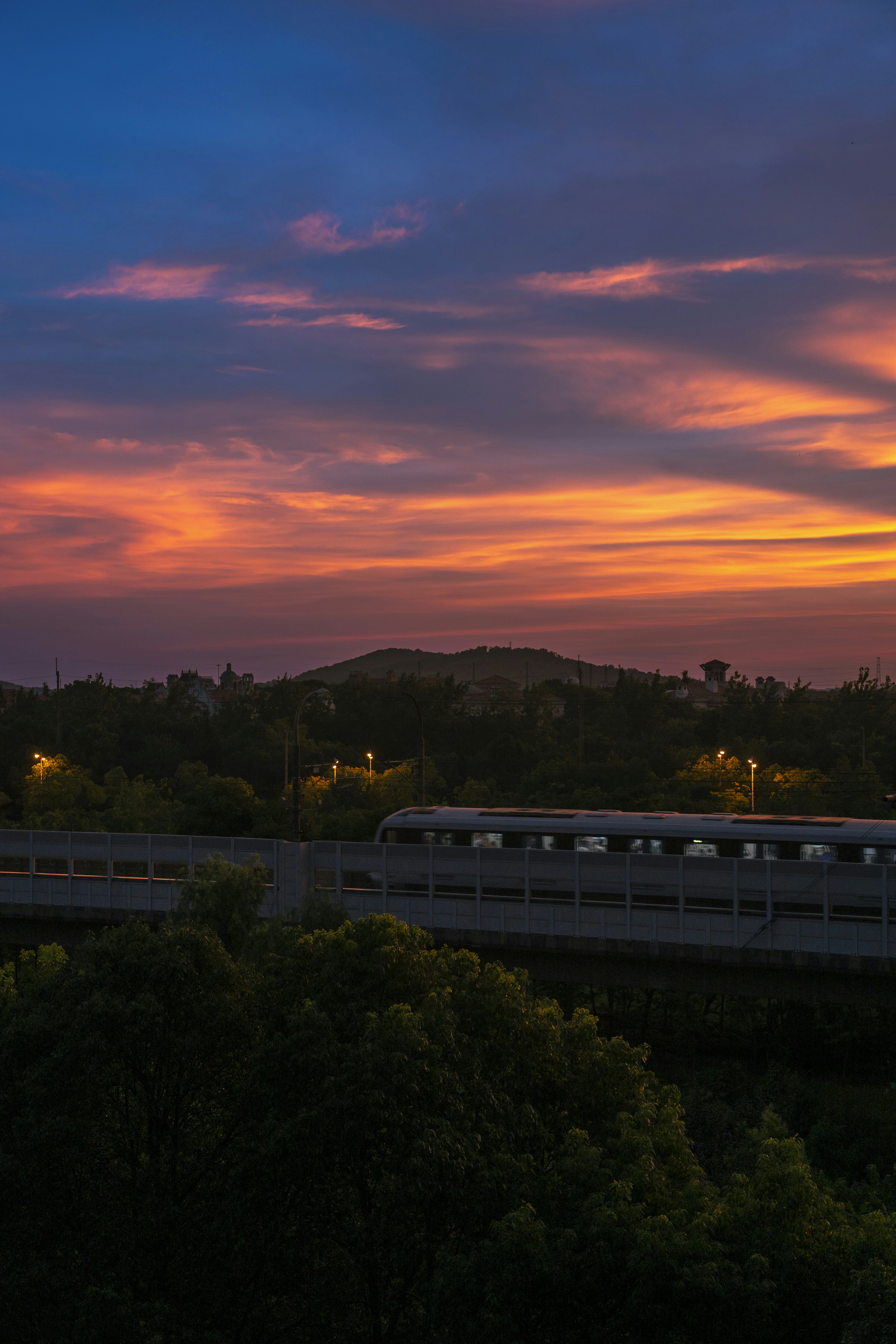 A subway shuttles in the evening sun