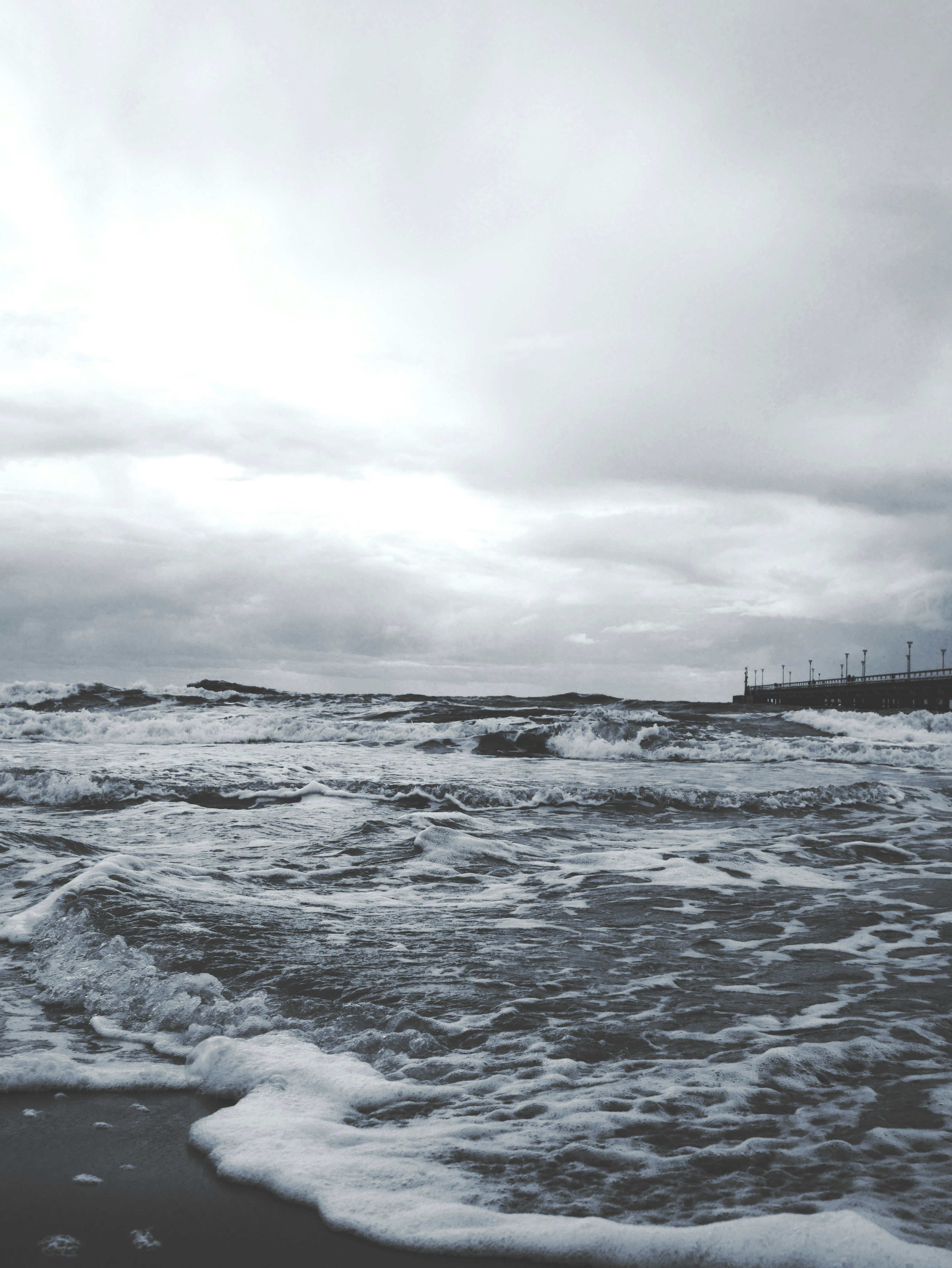 Cloaked in Gray: The Pier Reaches into a Moody Sea Horizon