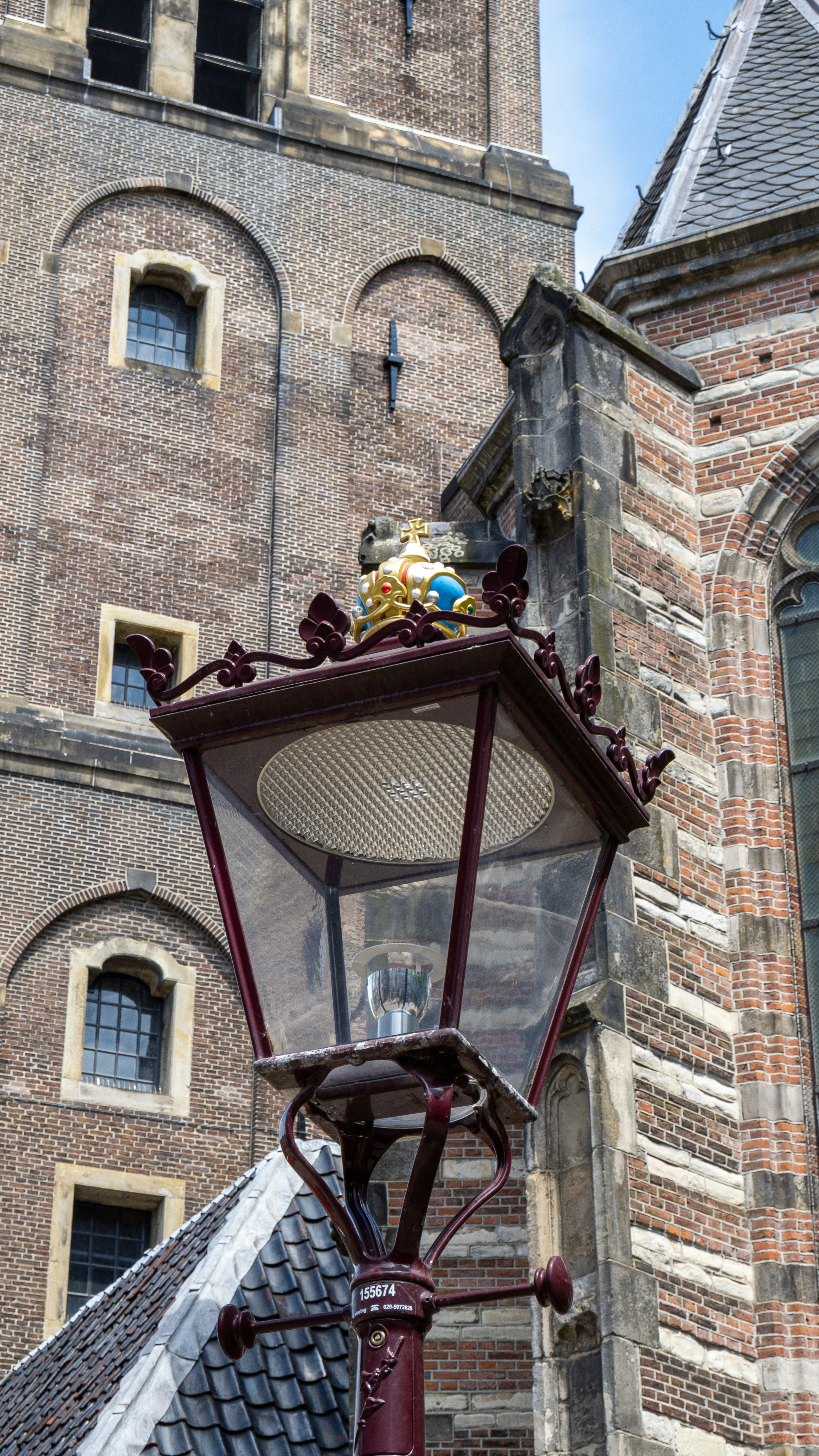 a lamp post with a statue on top of it