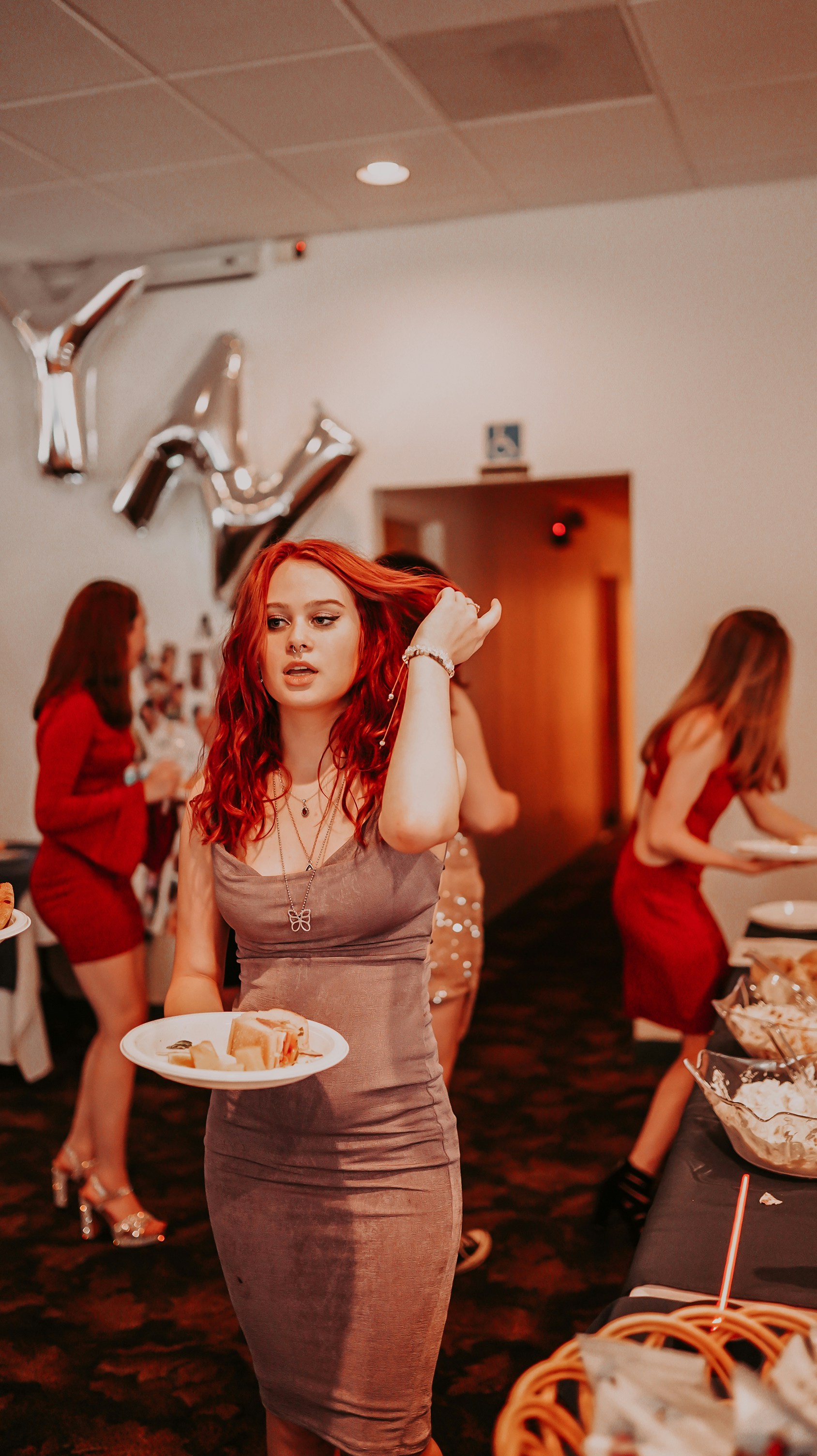 Crimson-Tressed Moment at a Velvet-Carpeted Reception