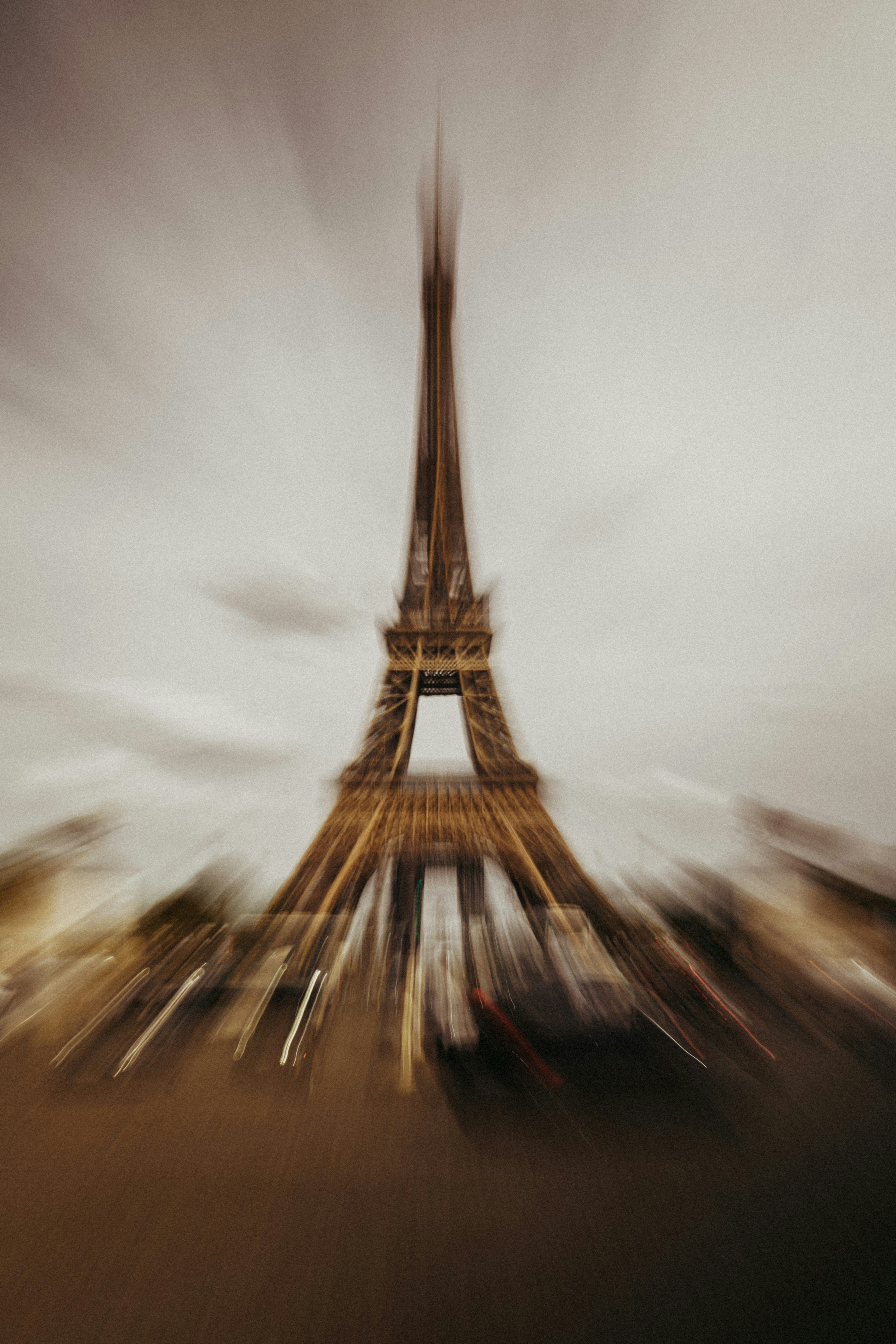 Eiffel Tower enveloped in a dynamic blur, conveying a sense of motion and energy in the bustling surroundings.