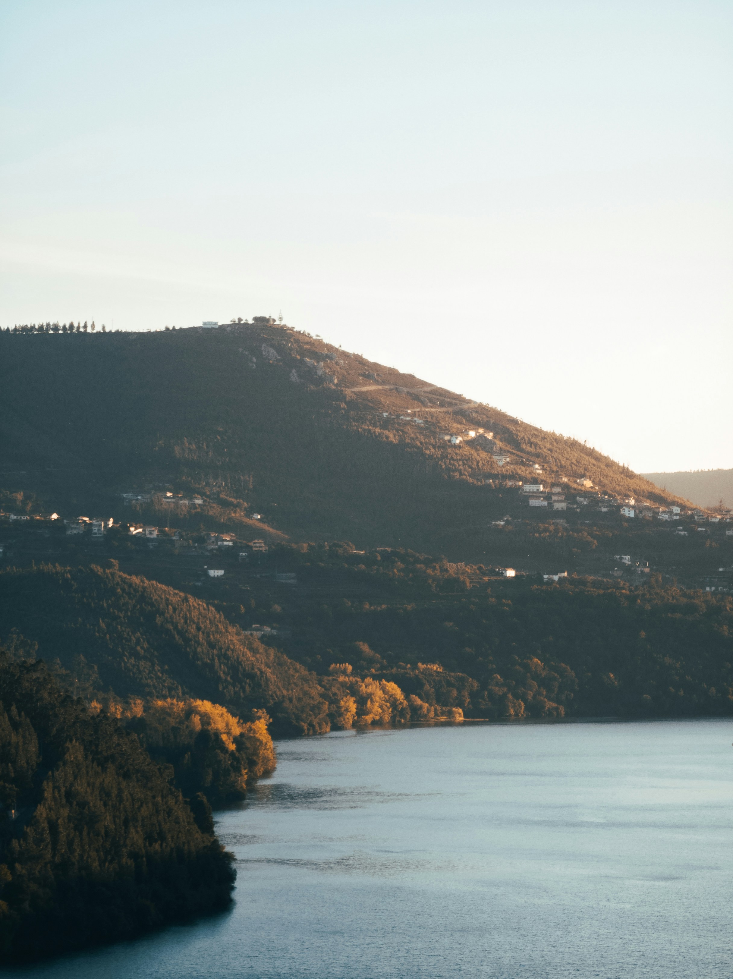 Dawn over the terraced hillside village by the river